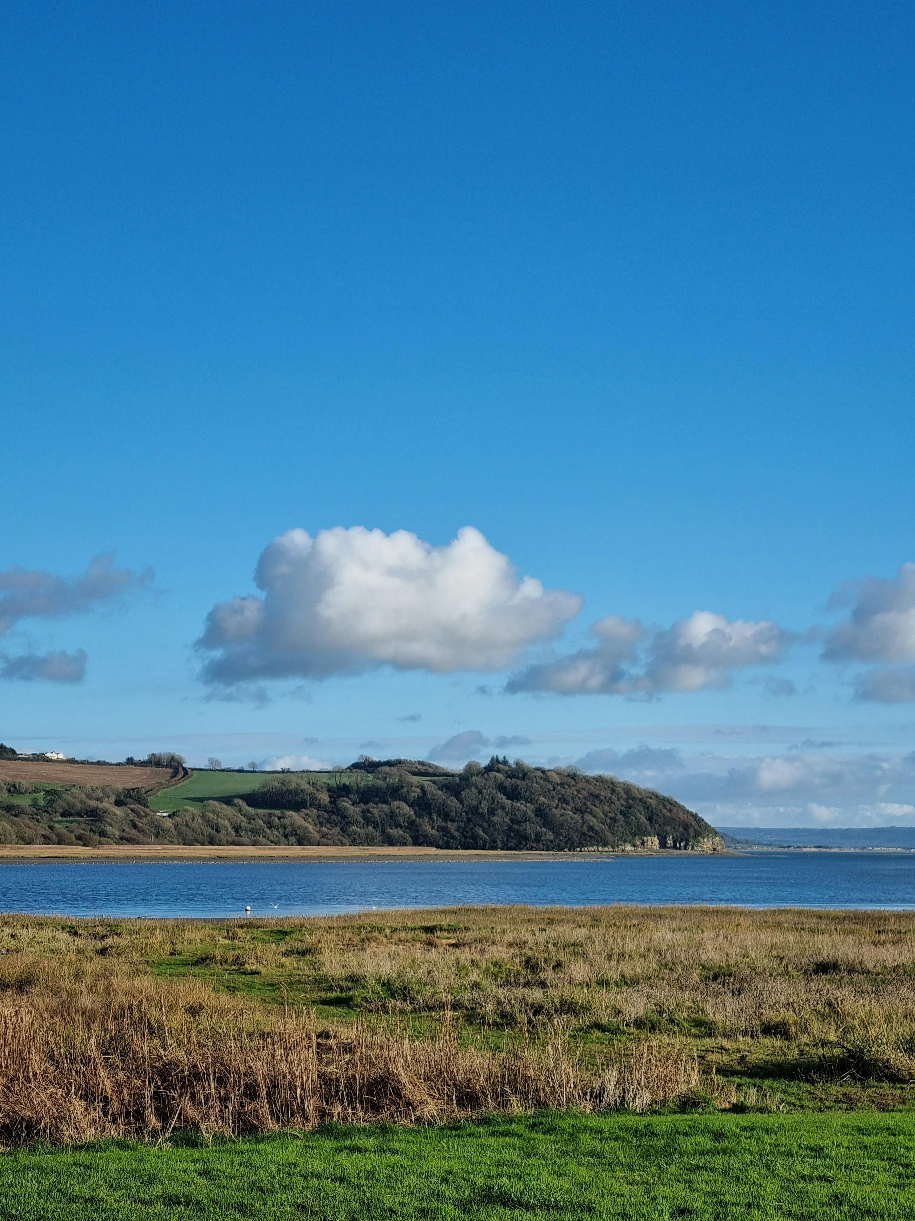 A Lake Near Rock Formation Under Blue Sky · Free Stock Photo