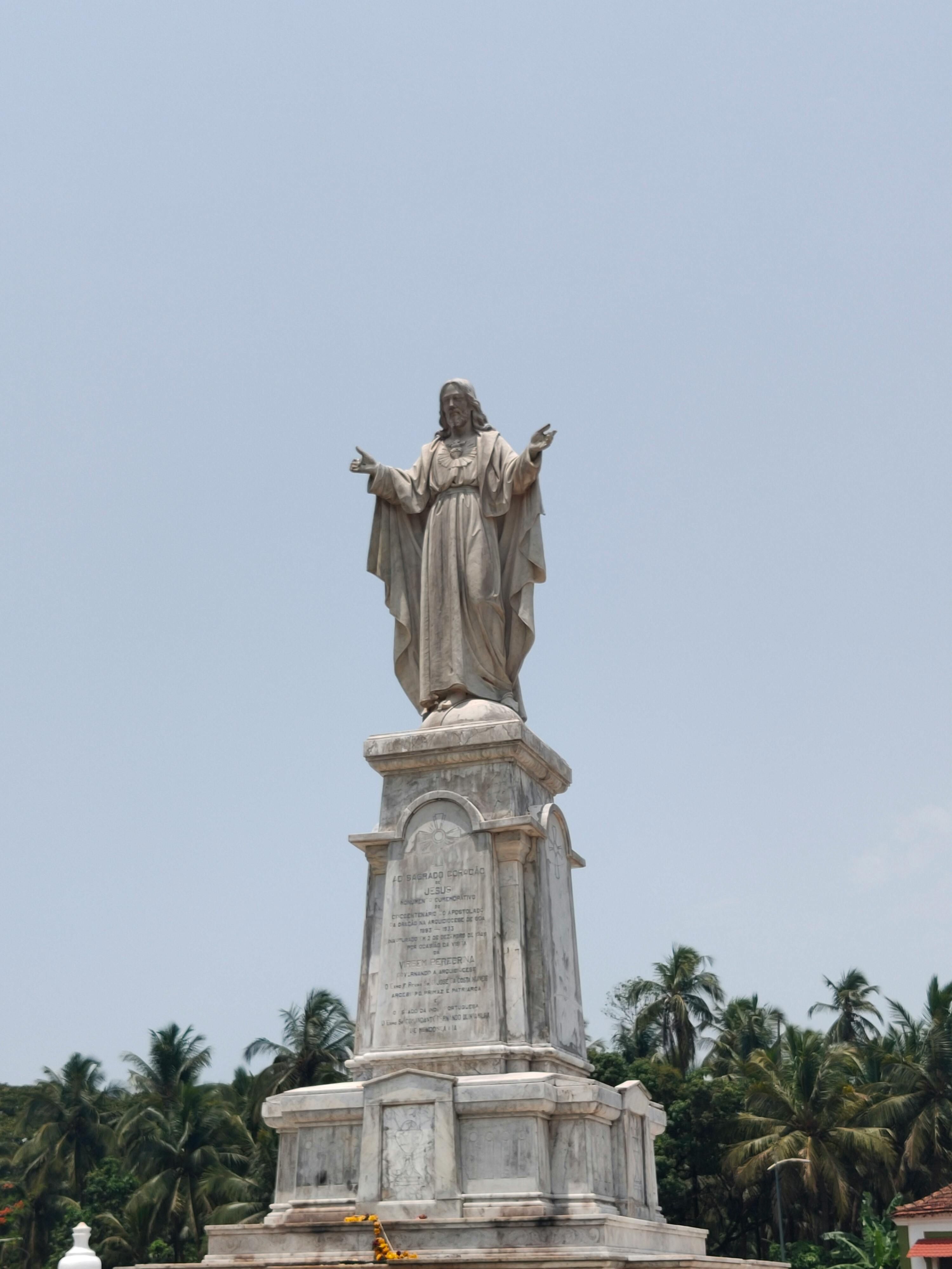 Statue of Jesus Near Palm Trees · Free Stock Photo