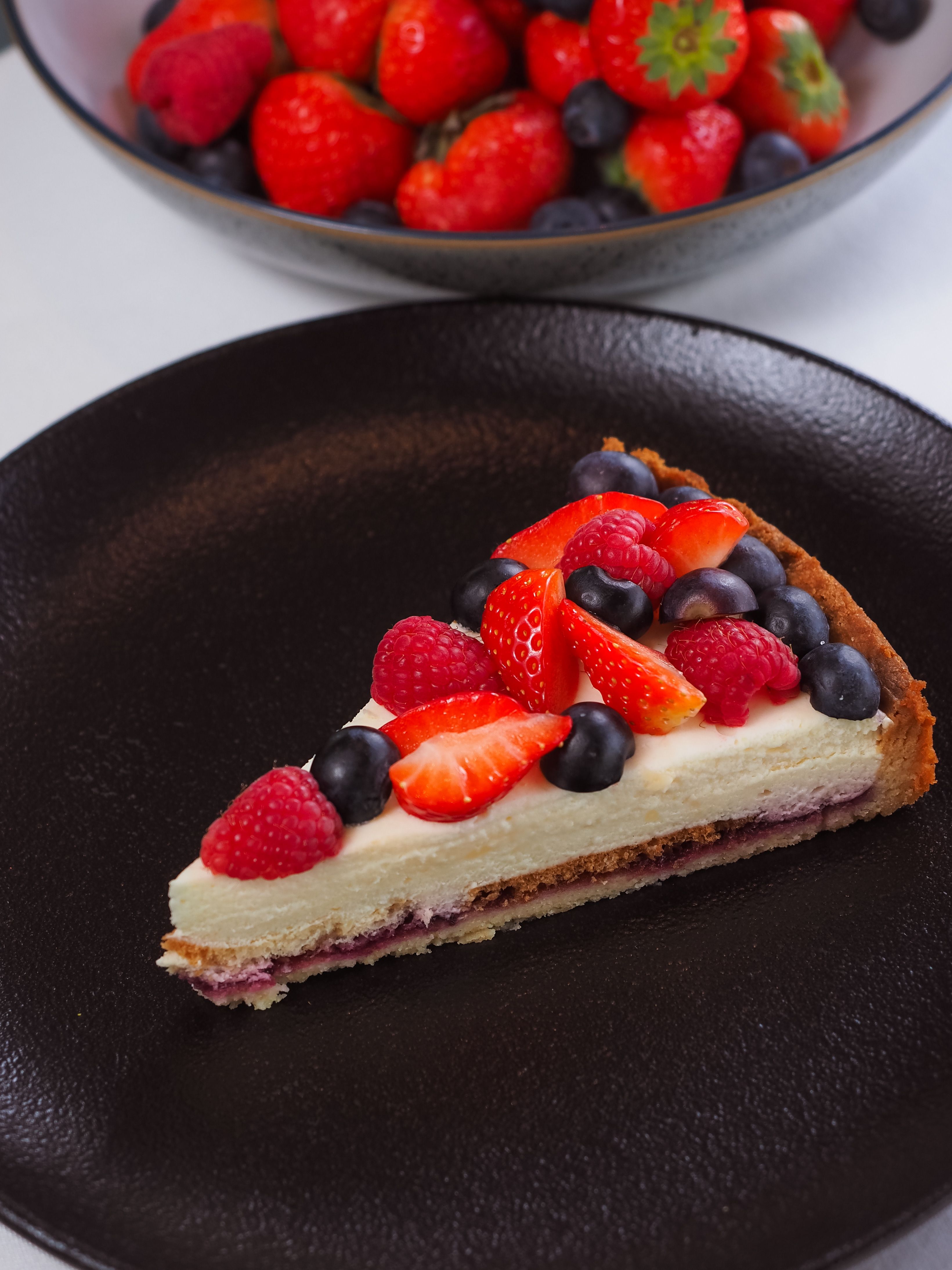A Sliced Cheesecake with Fruits on Top · Free Stock Photo