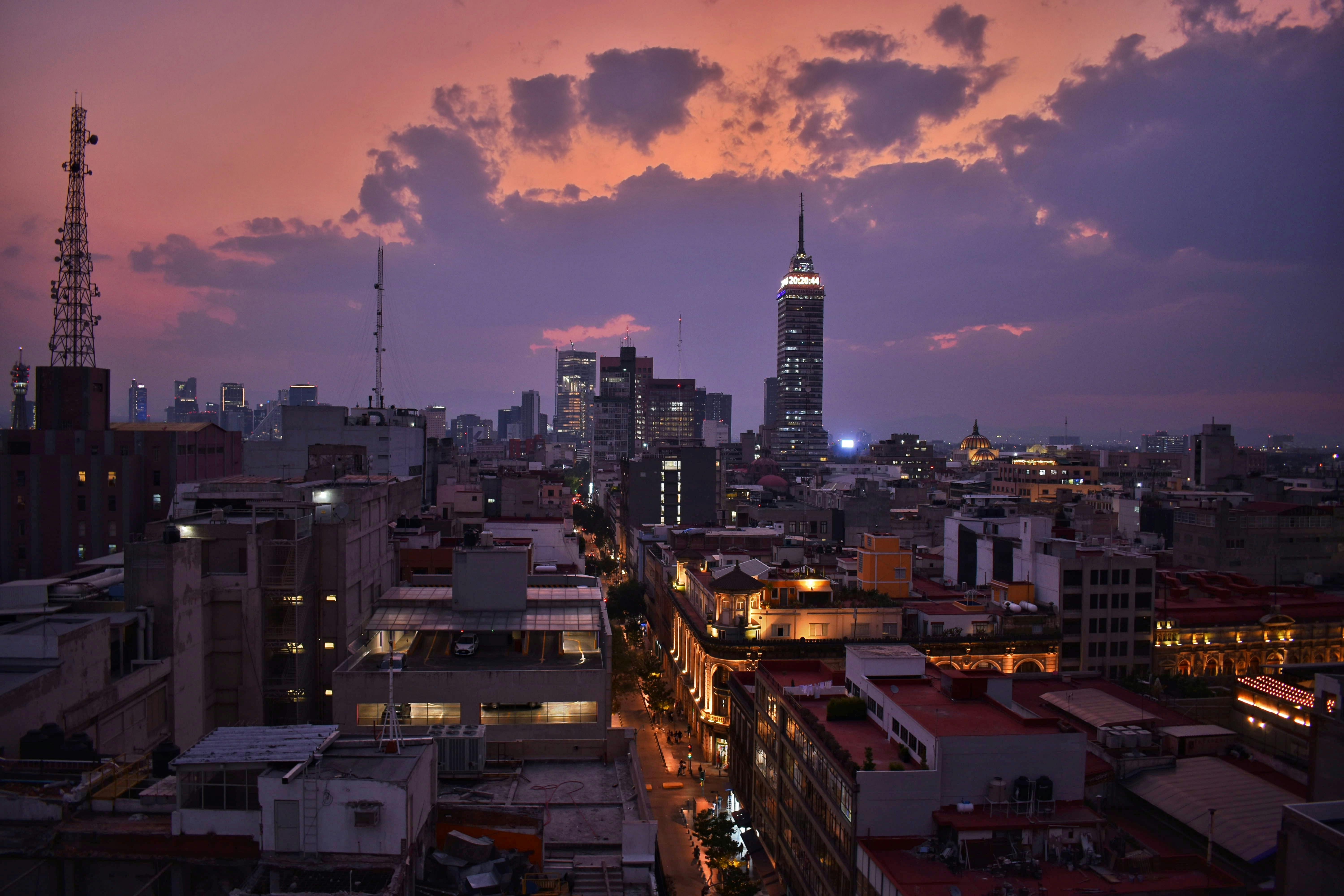 Illuminated Buildings Under a Cloudy Sky · Free Stock Photo