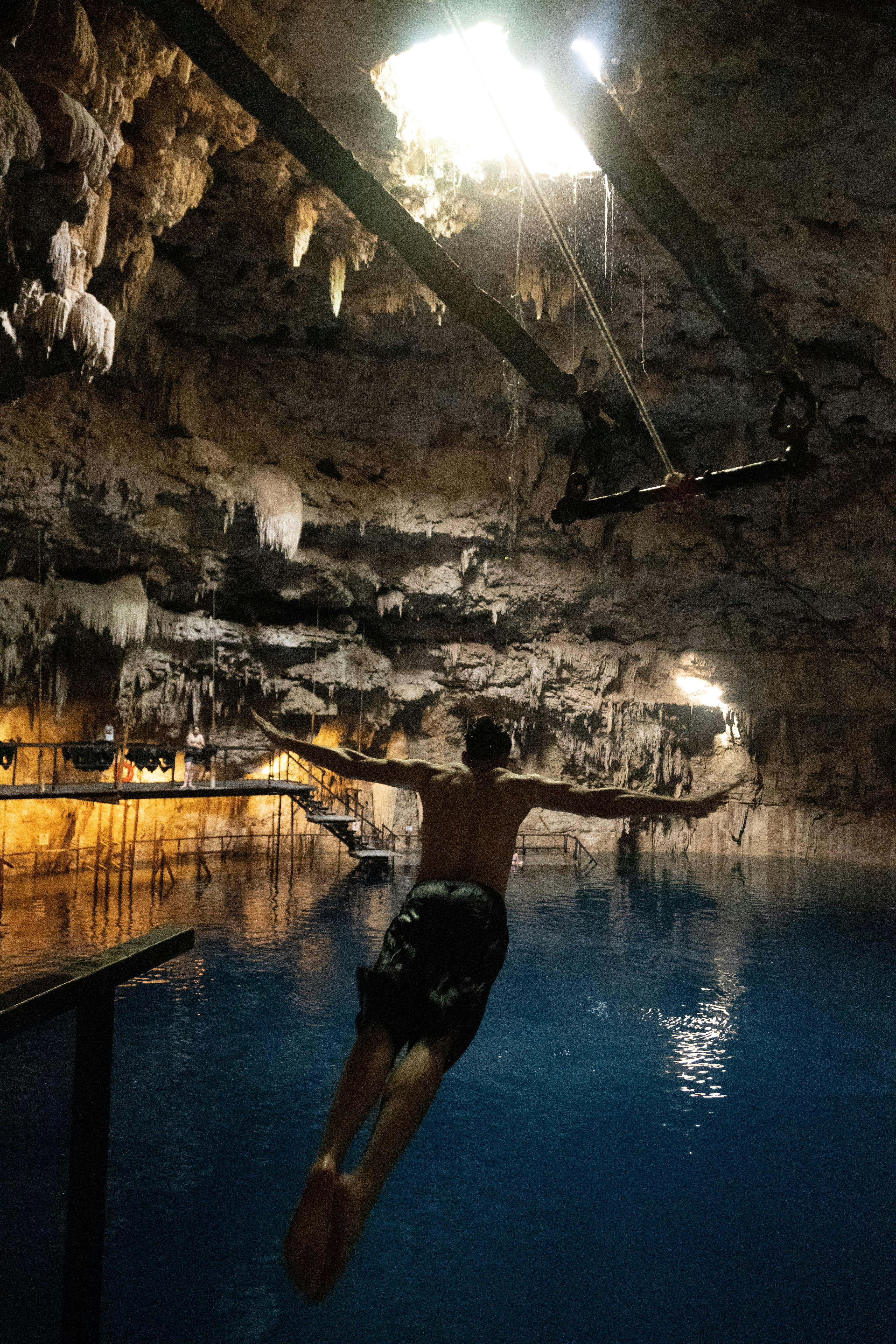 A Man Diving on a Underground Lagoon · Free Stock Photo