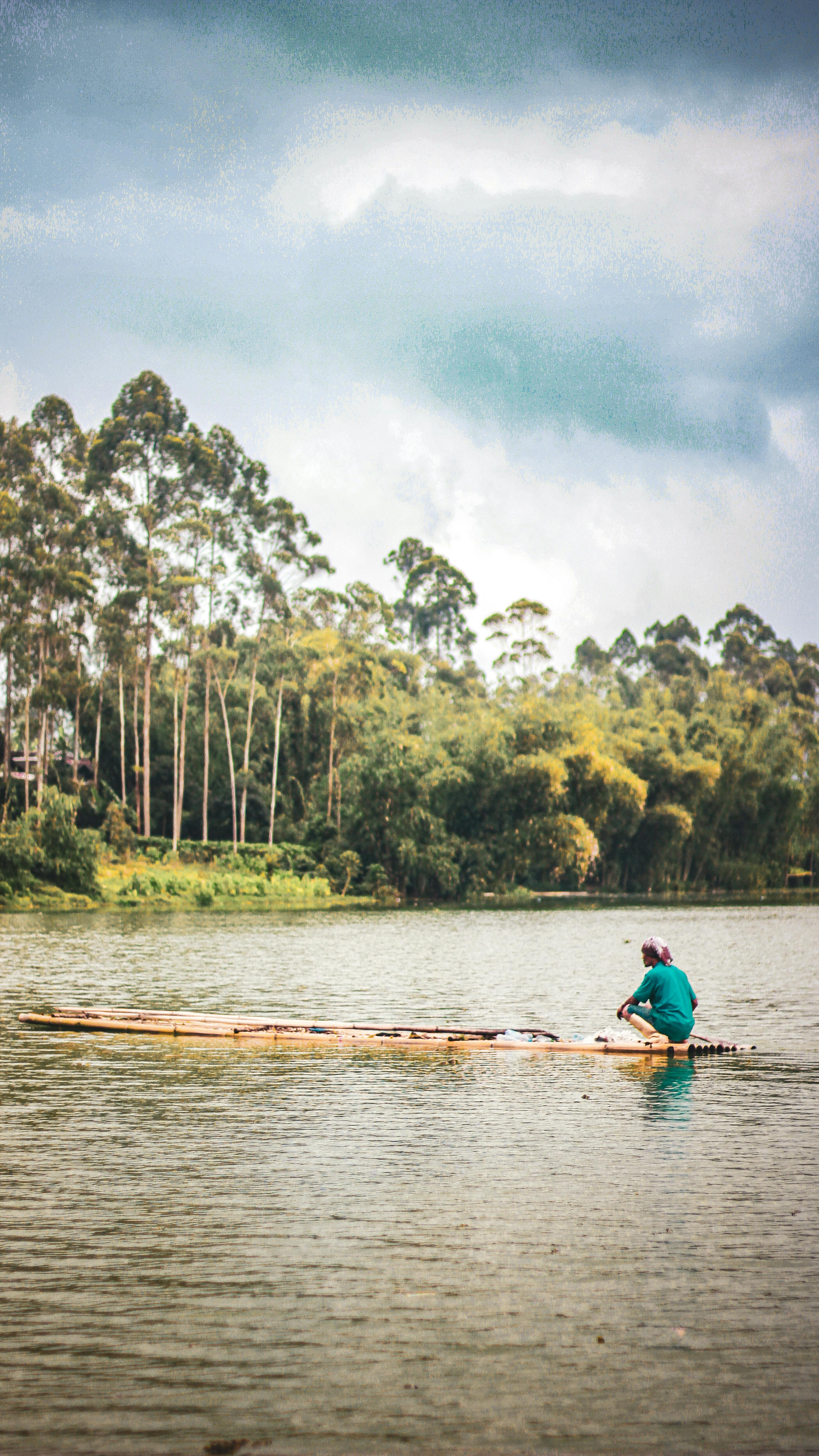 A Person Riding on a Raft Floating on the Lake · Free Stock Photo