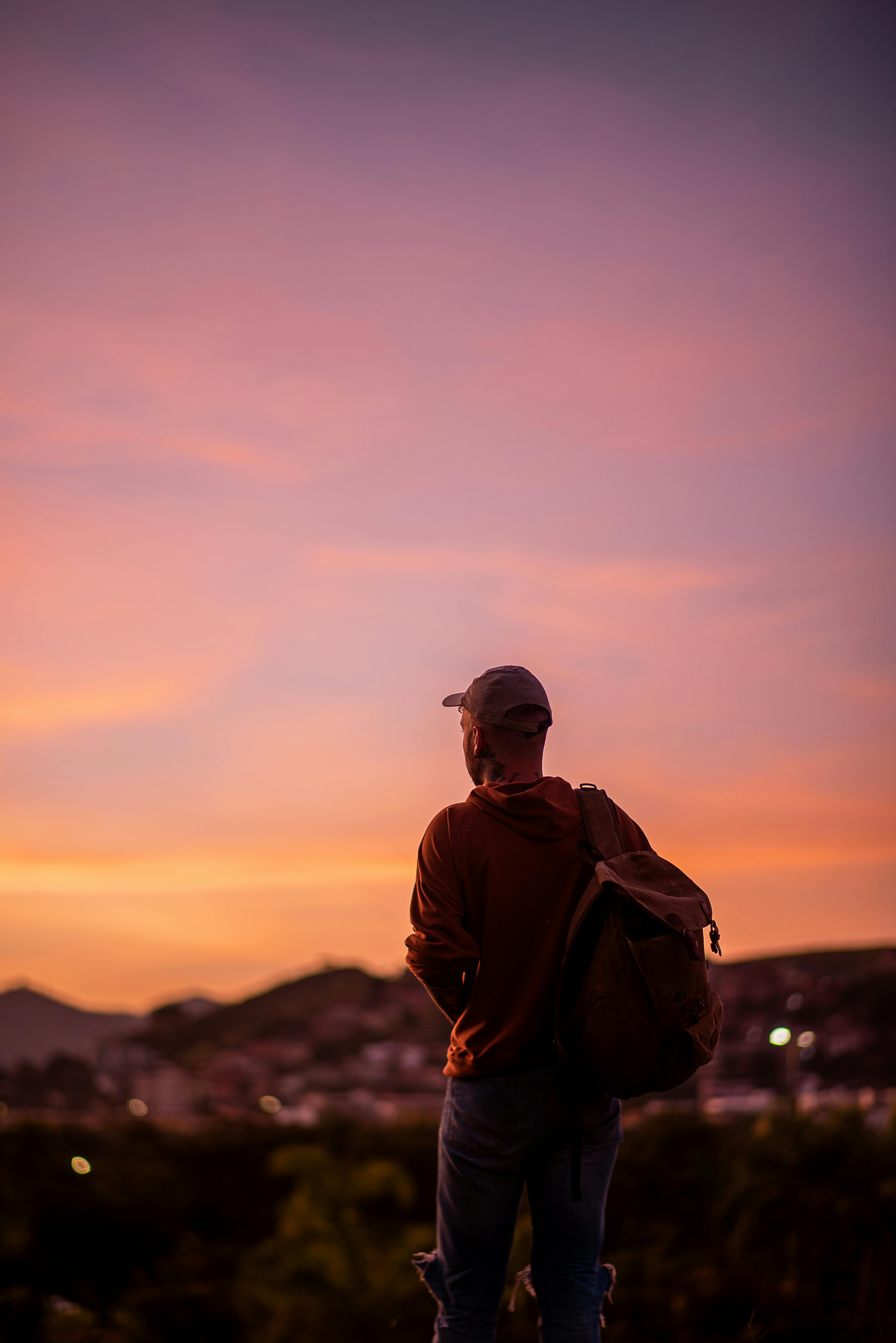 A Backpacker Standing on Big Rock · Free Stock Photo