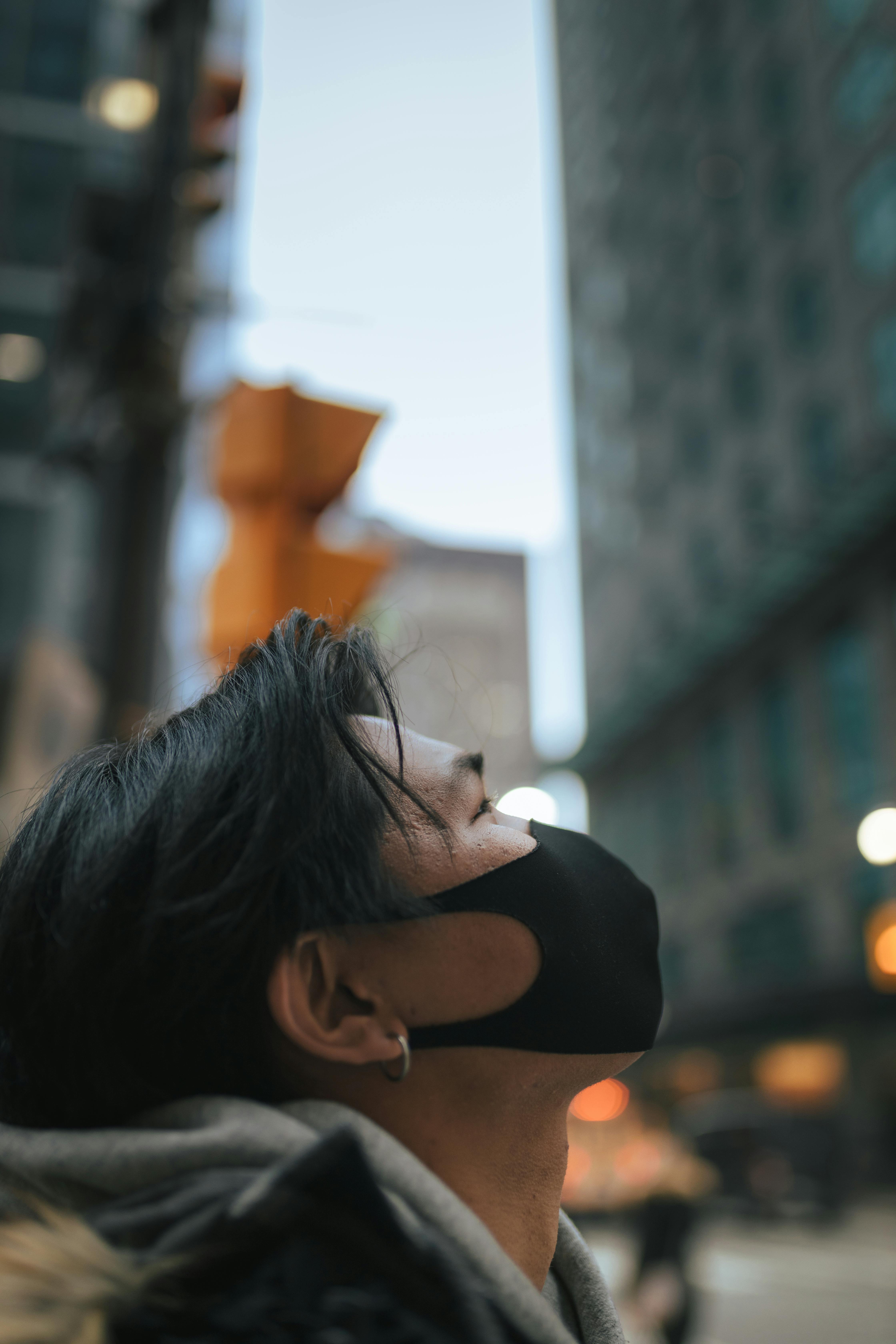 A Man in Black Face Mask Looking at the Building · Free Stock Photo