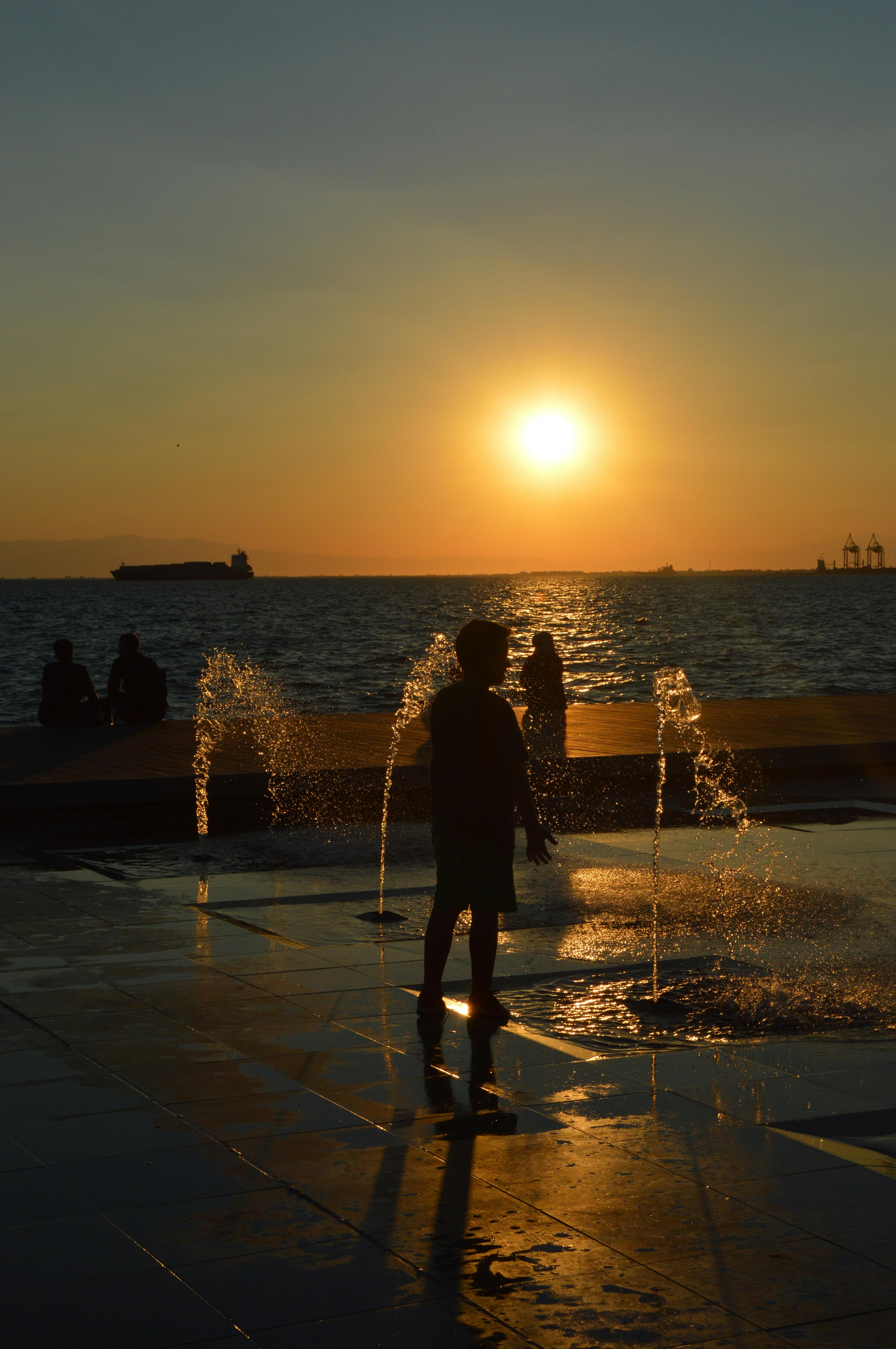 Silhouette of a Person Standing on a Water Fountain · Free Stock Photo