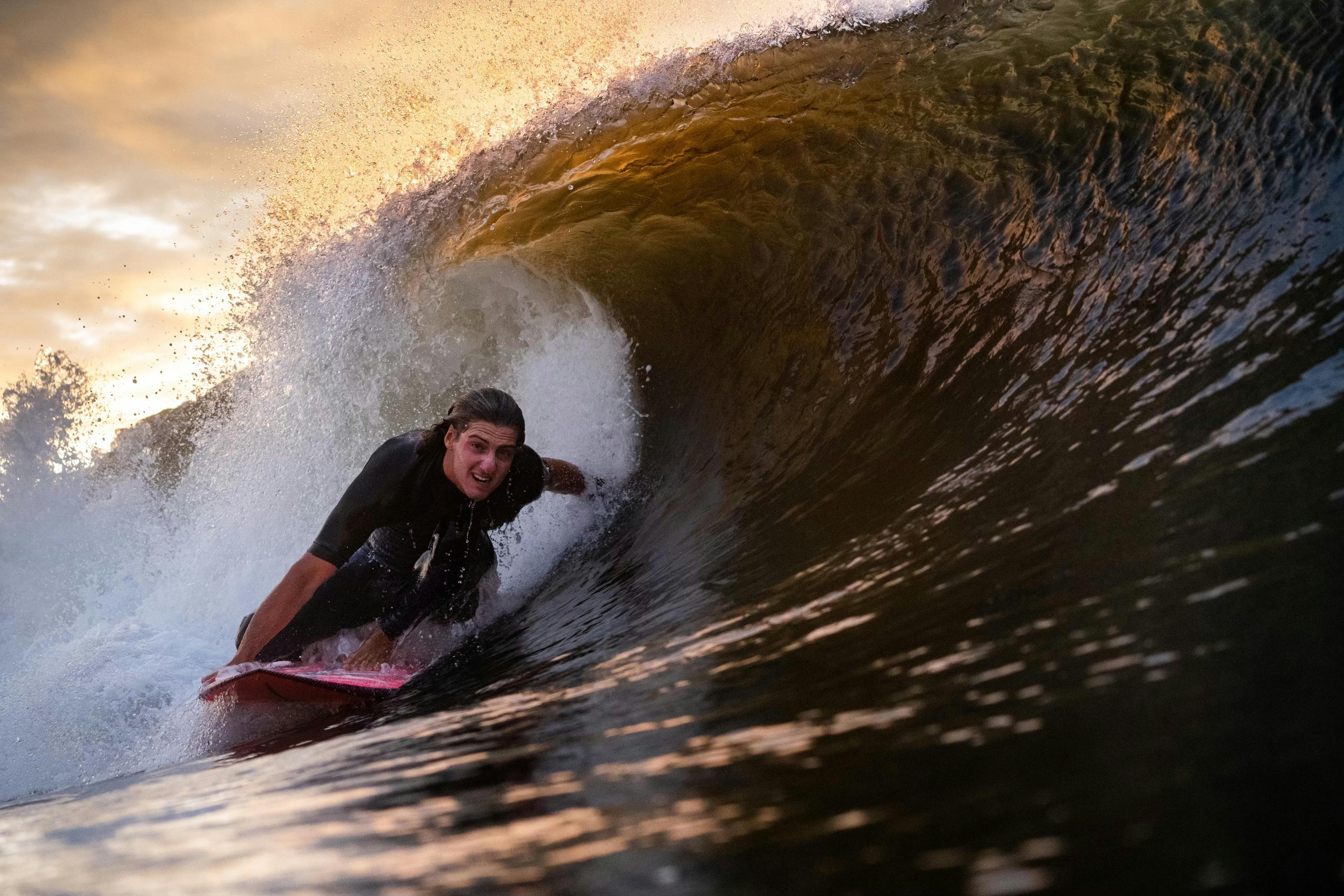A Man Surfing on Waves · Free Stock Photo