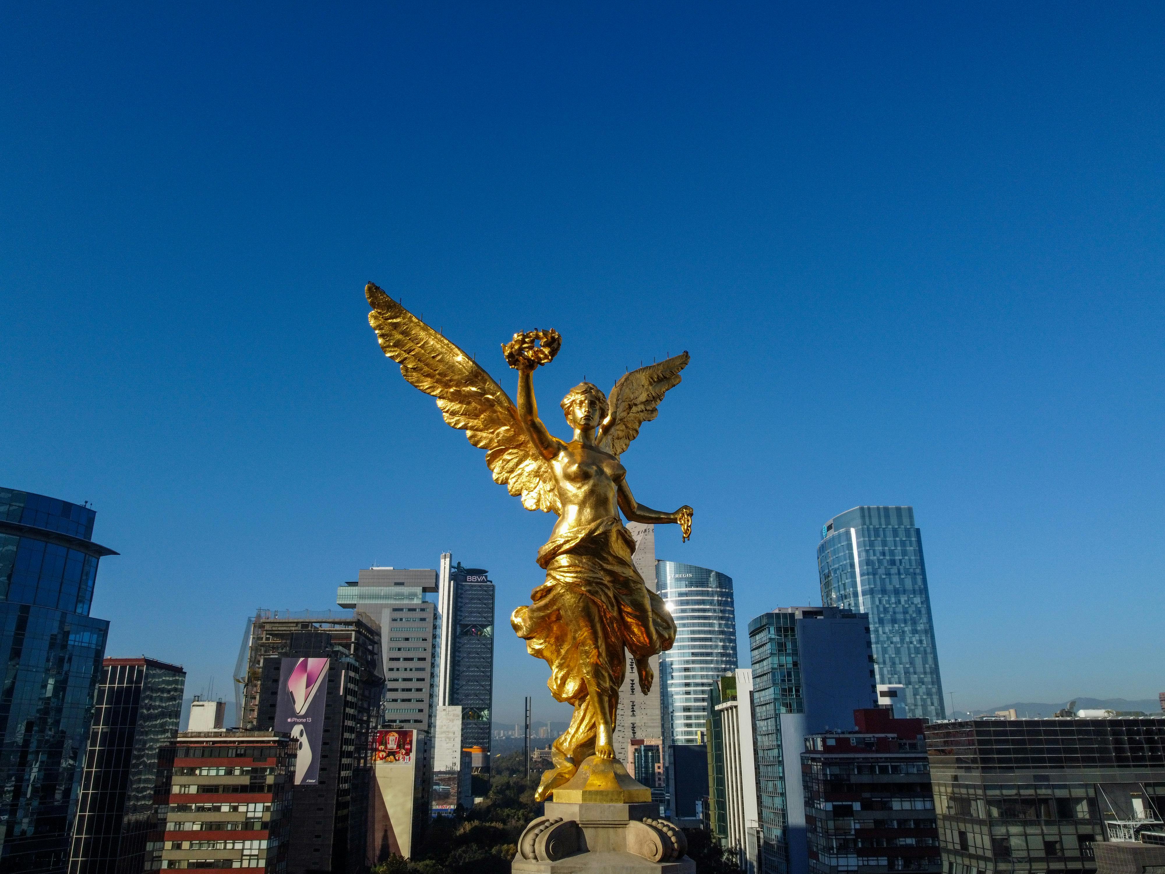 Golden Statue Under Blue Skies during Day Time · Free Stock Photo
