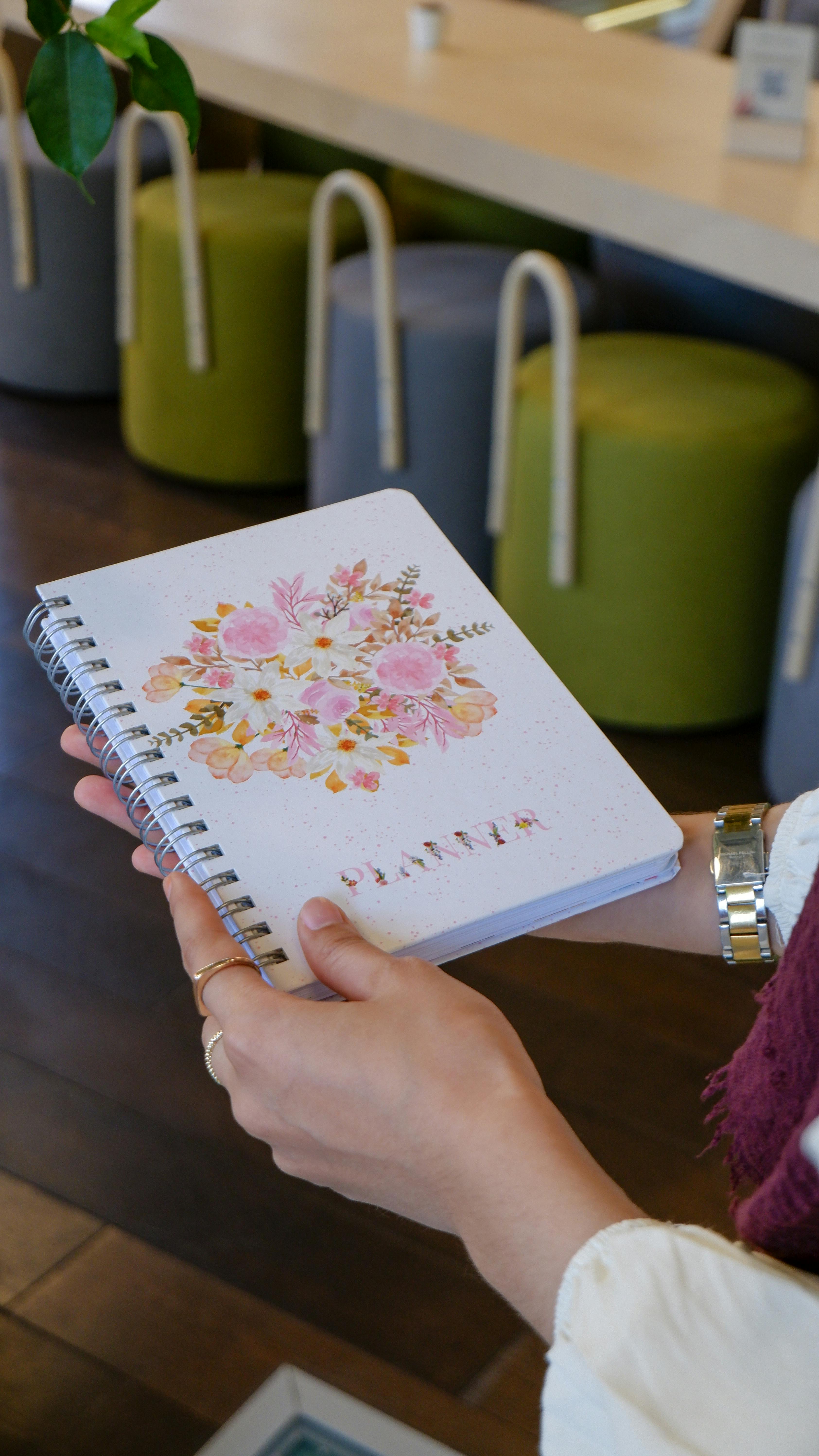 Person Holding a Spiral Notebook · Free Stock Photo