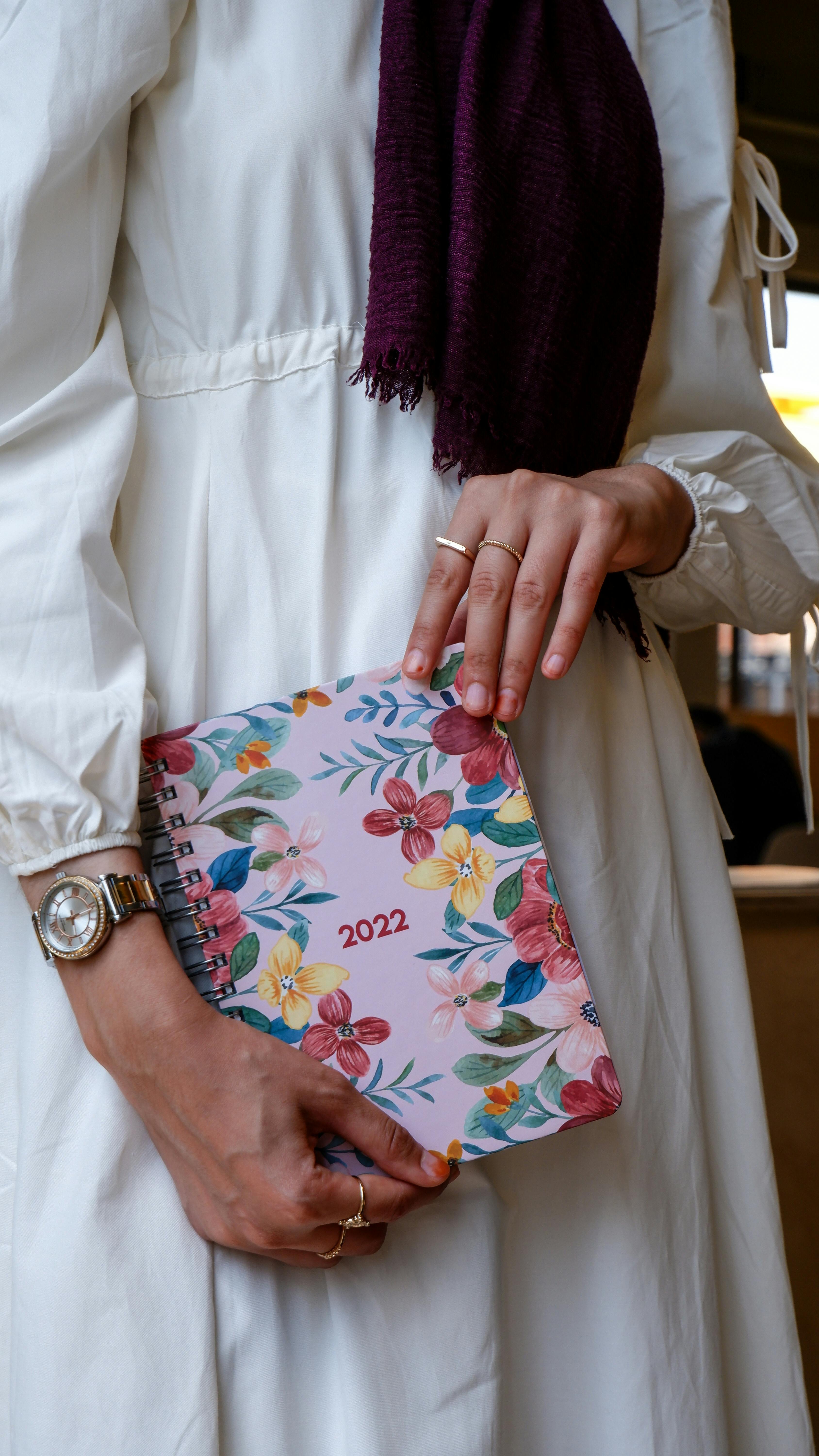 A Person Holding a Floral Notebook · Free Stock Photo