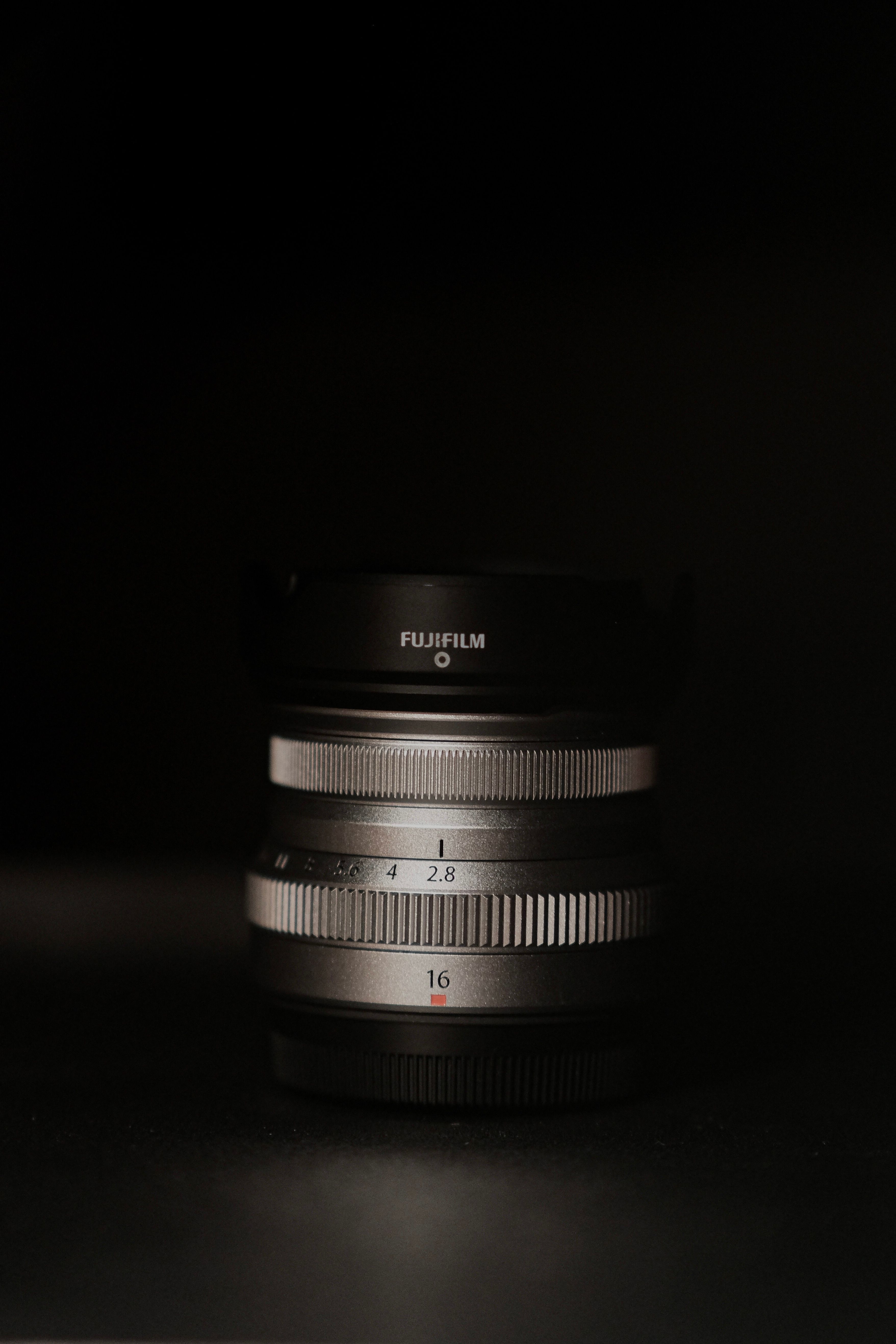 Close-Up Shot of a Camera Lens on Black Surface · Free Stock Photo