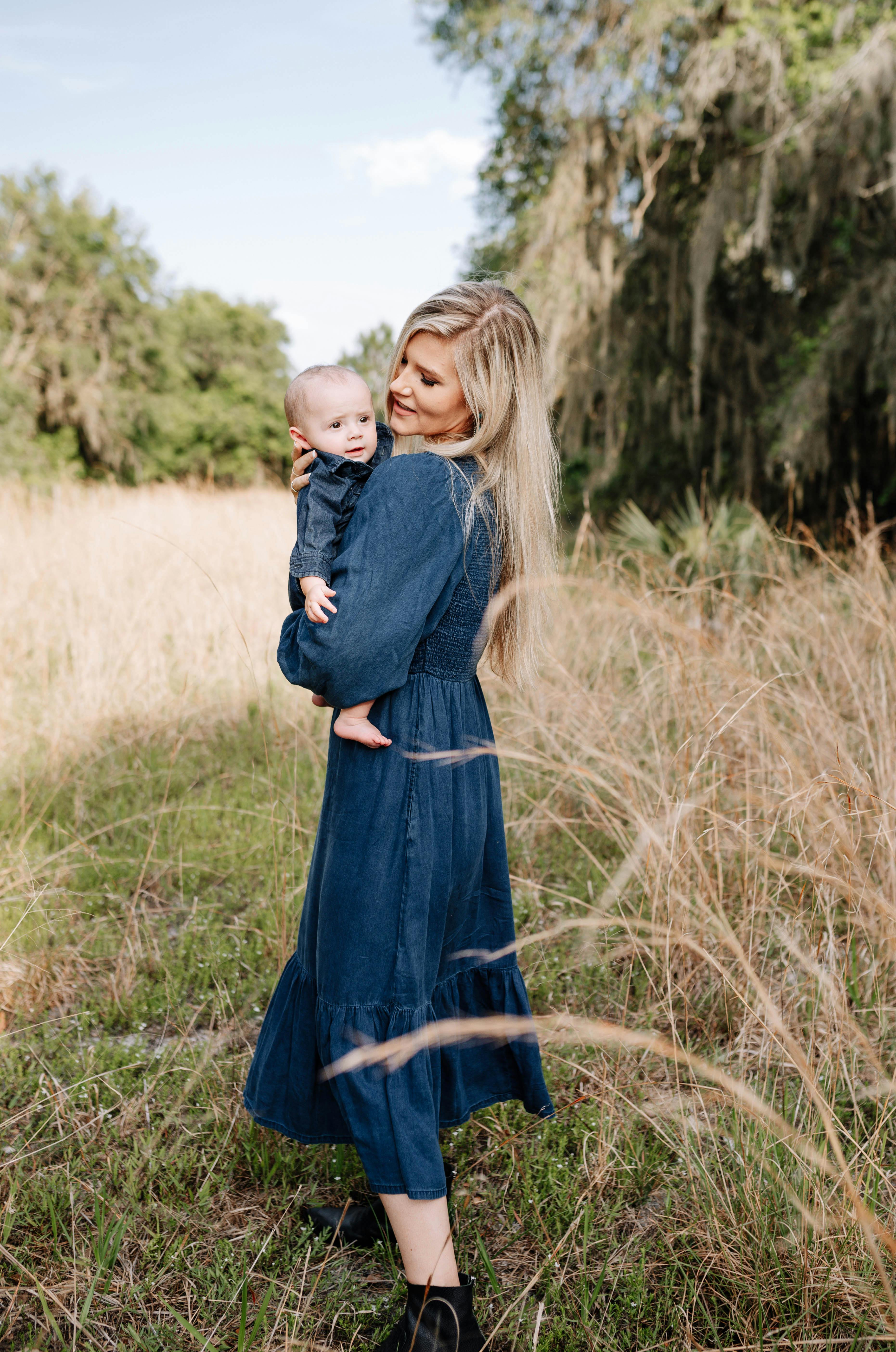 A Woman Carrying Her Baby · Free Stock Photo