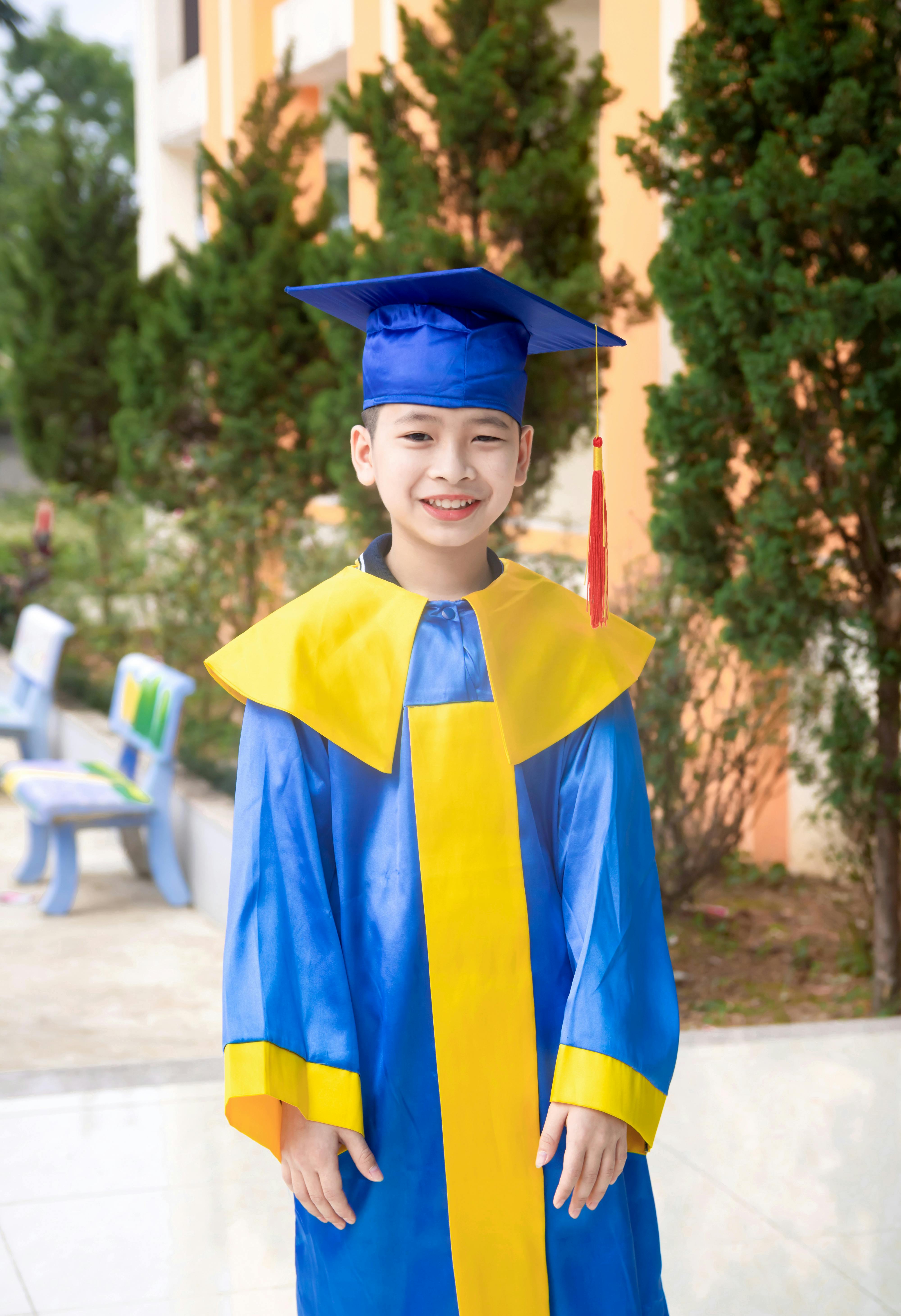 Children Wearing White Academic Gown during Graduation Ceremony at ...