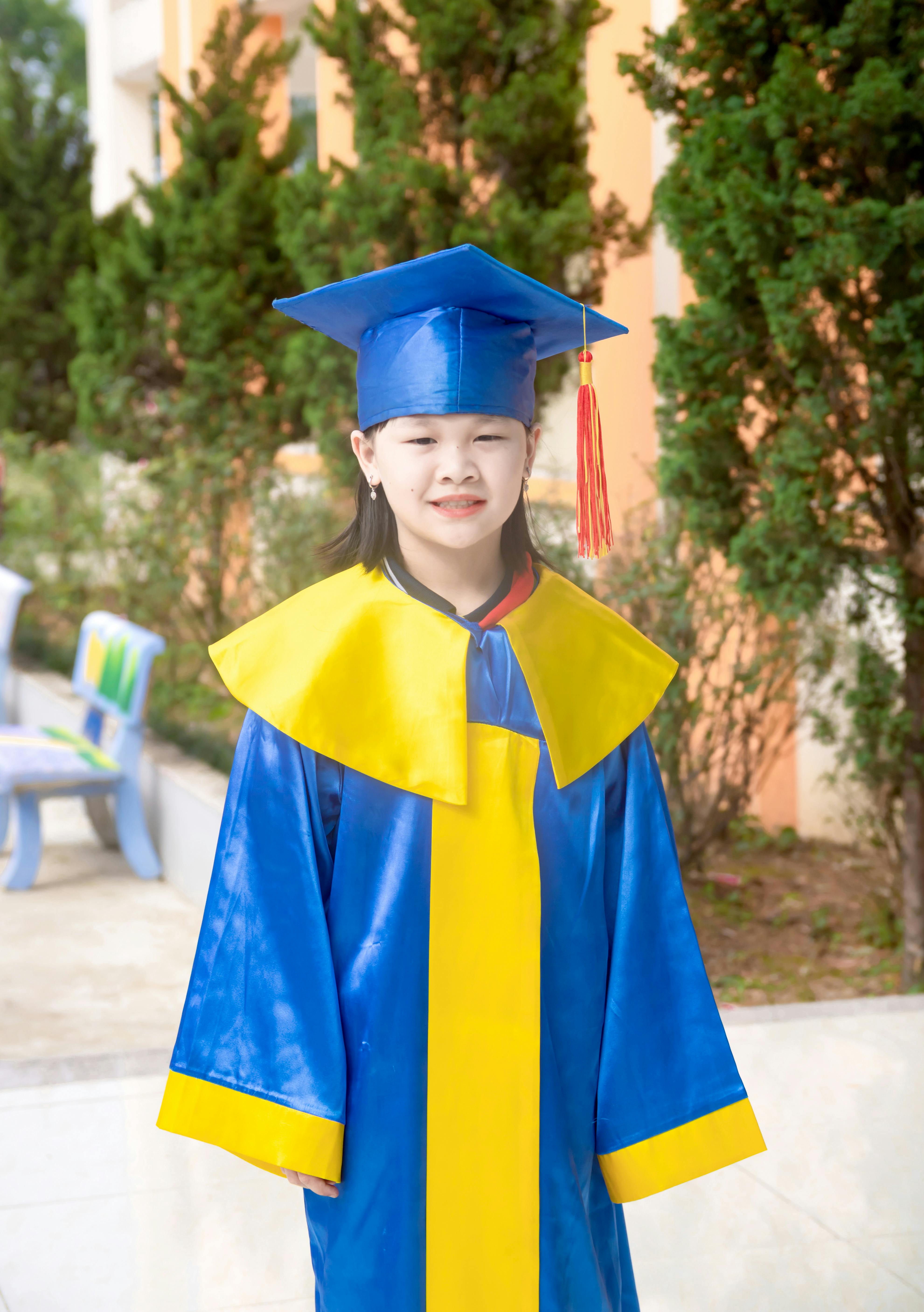 A Girl Wearing Blue Toga Standing while Looking at the Camera · Free ...