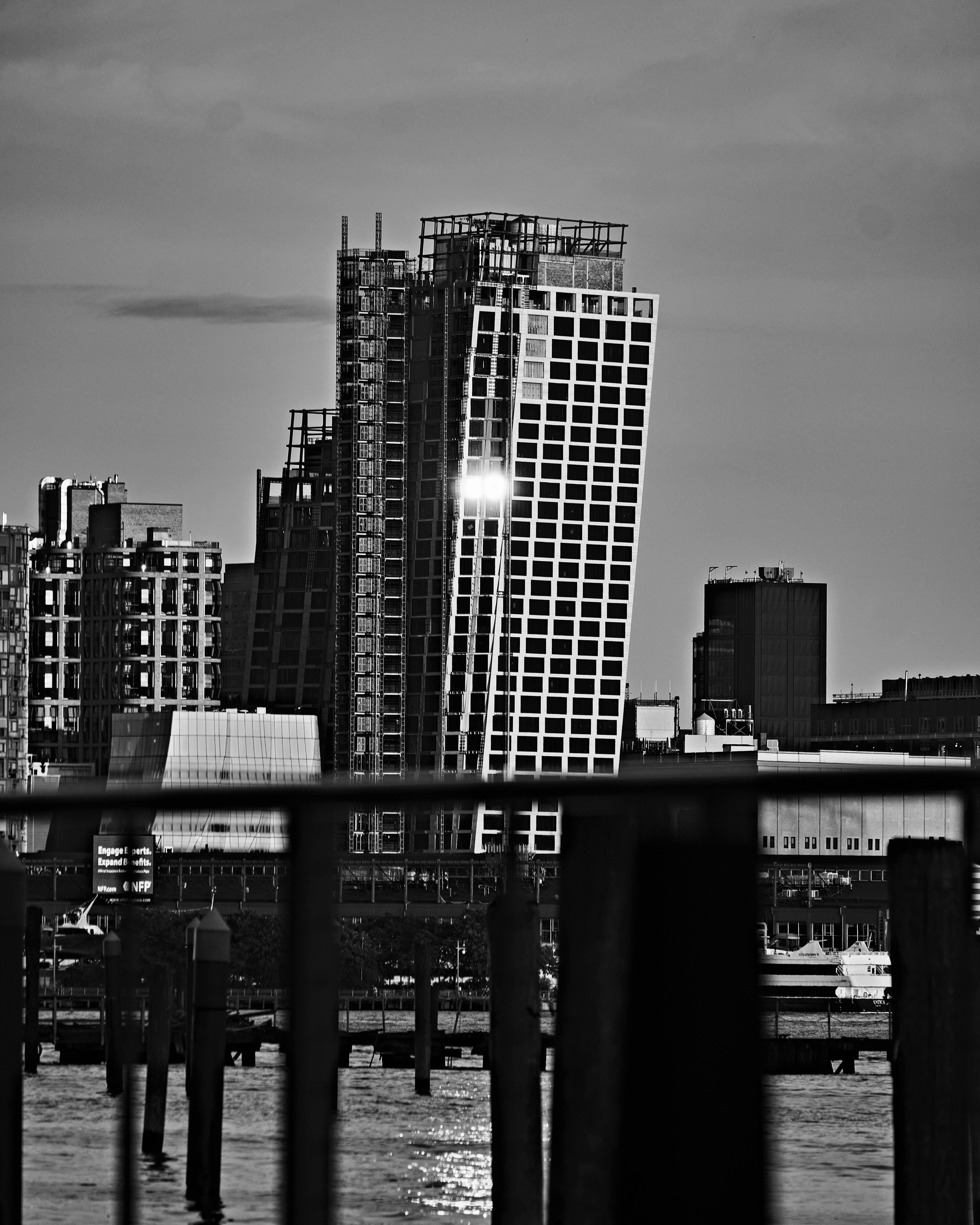 A Grayscale Photo of a Bridge In between Body of Water · Free Stock Photo