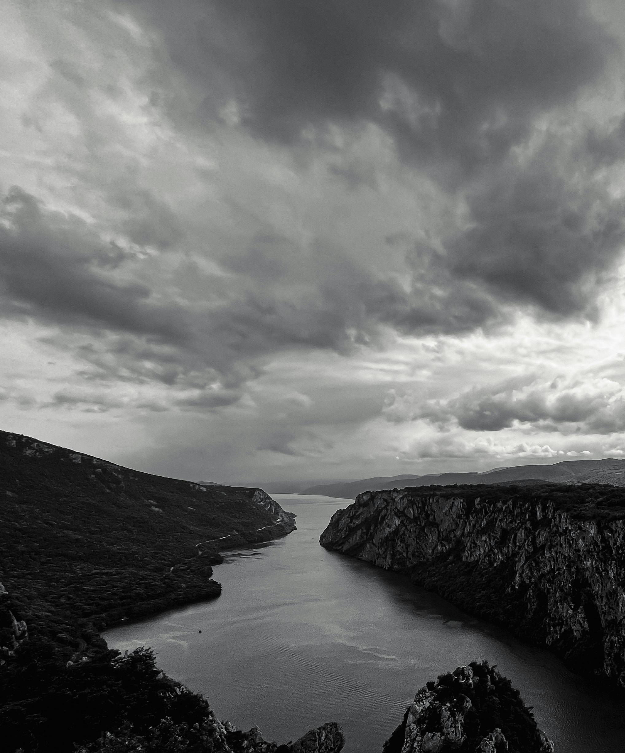 Grayscale Photography of Sea Between Cliffs · Free Stock Photo