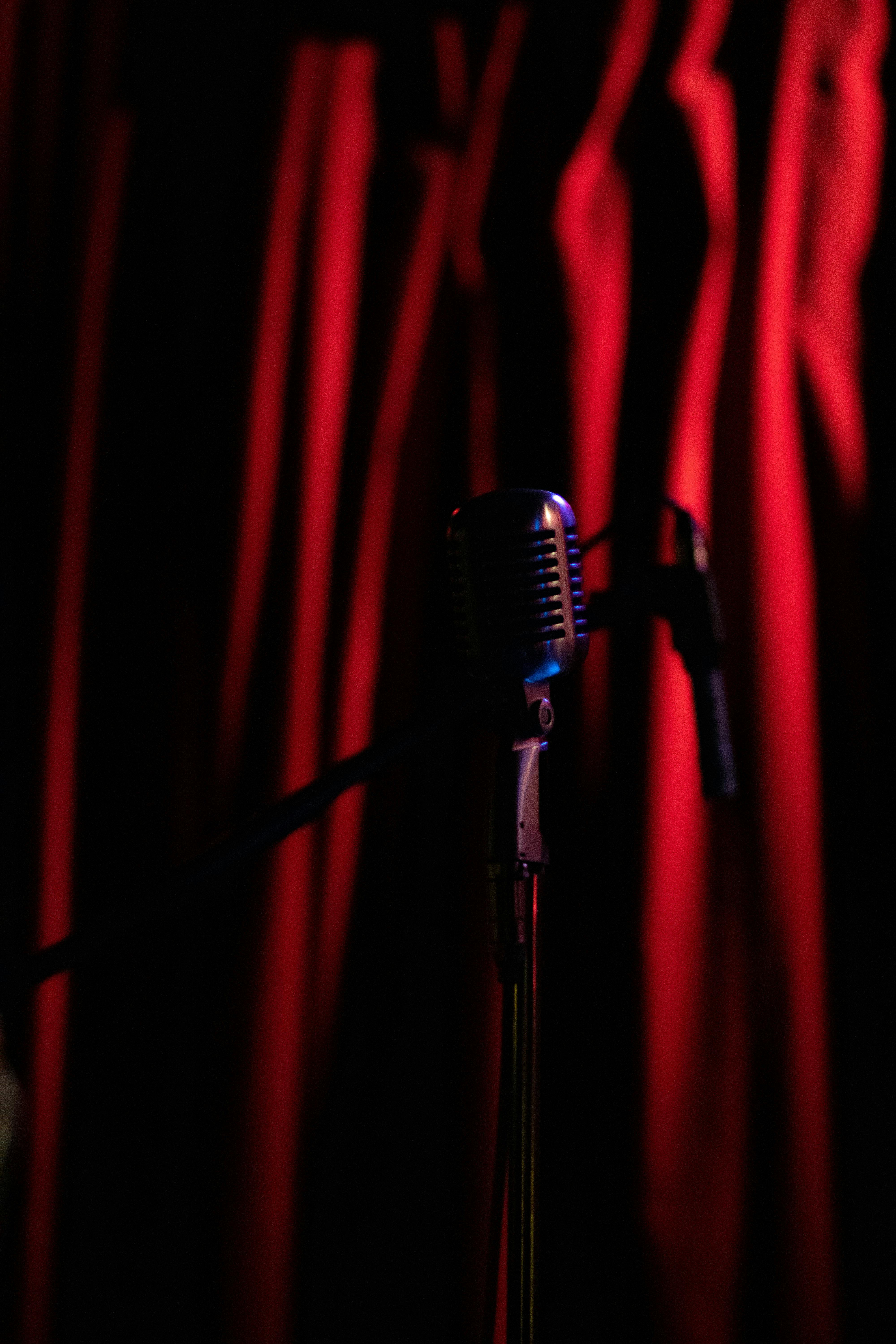 Photograph of a Microphone Near a Red Curtain · Free Stock Photo