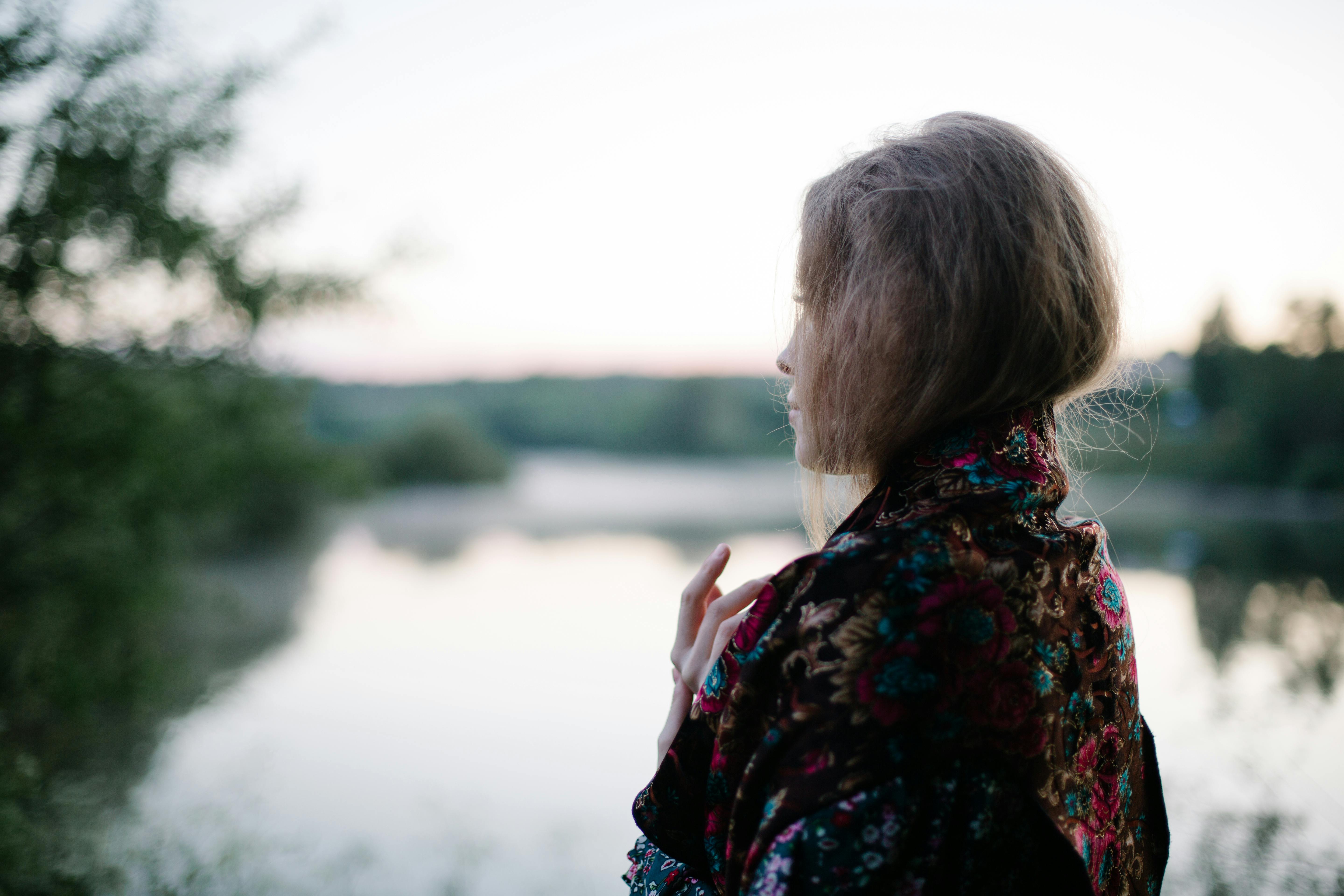 Side View Shot of a Woman in Floral Scarf Looking at the Beautiful ...