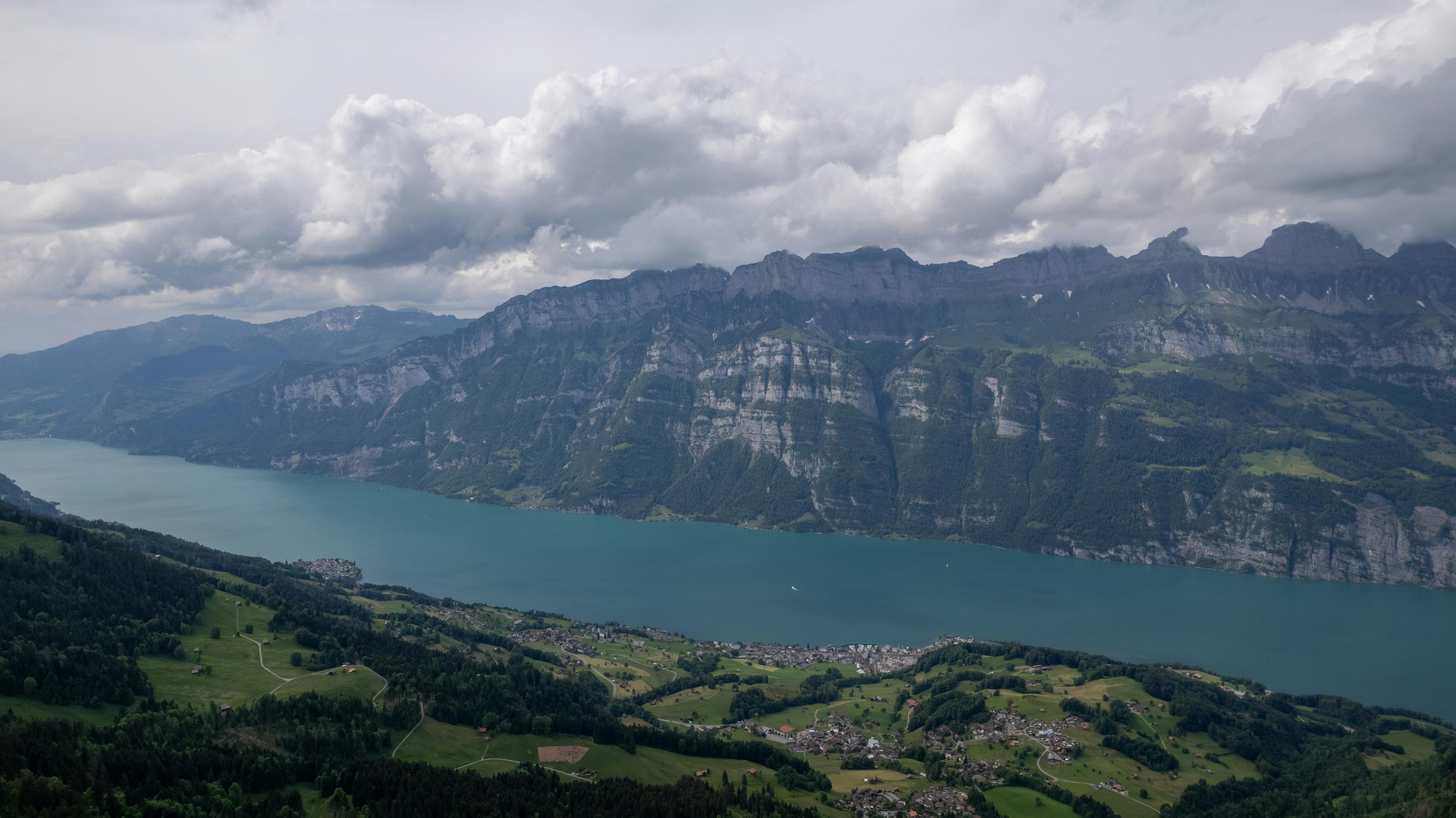 Aerial Photography of Lake between Mountains under the Cloudy Sky ...