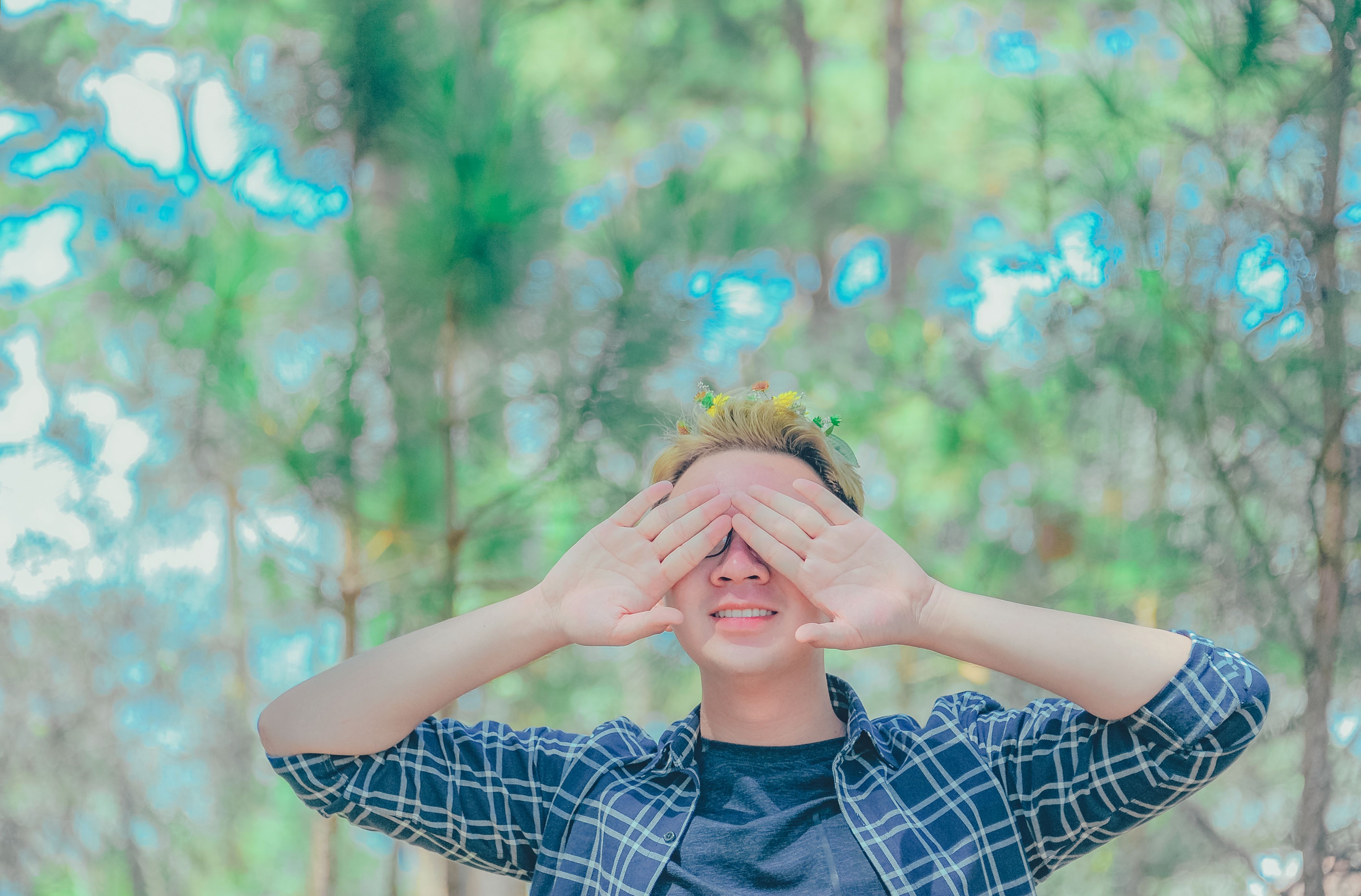 Man Covered Eyes by His Hand Standing on Surrounded Trees · Free Stock ...