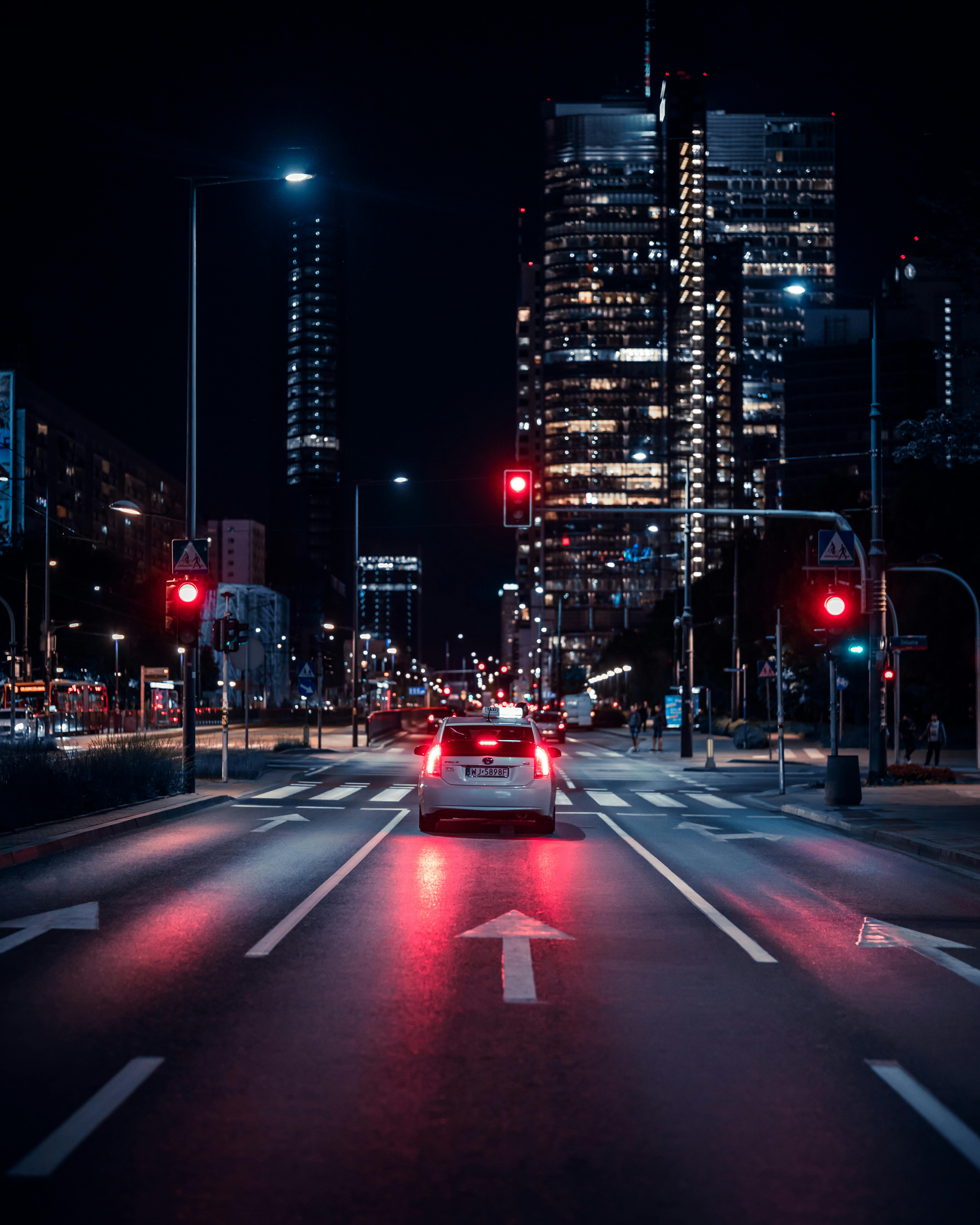 A Car Stopping on the Road Near Stop Light · Free Stock Photo