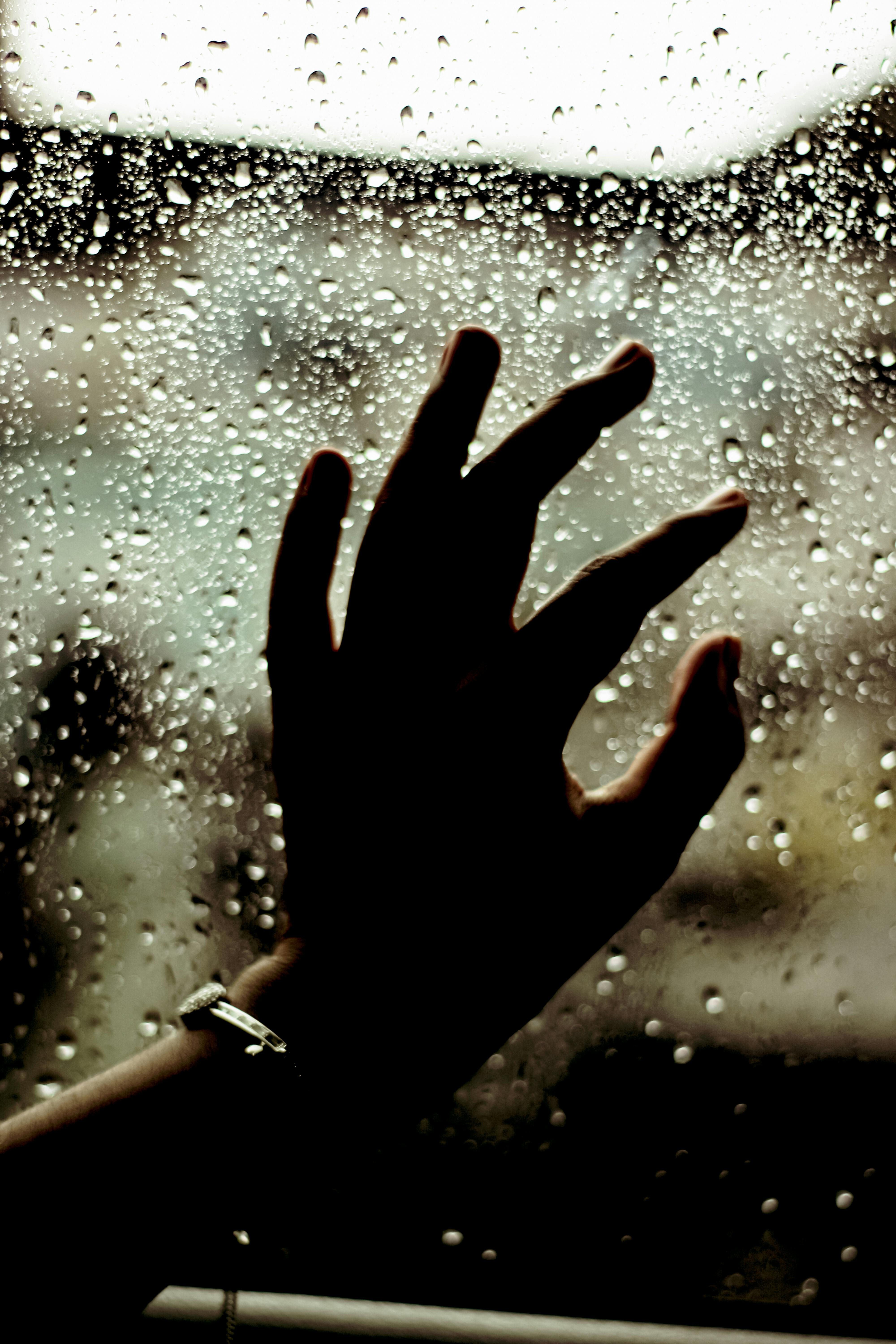 Hand and Raindrops on Window · Free Stock Photo