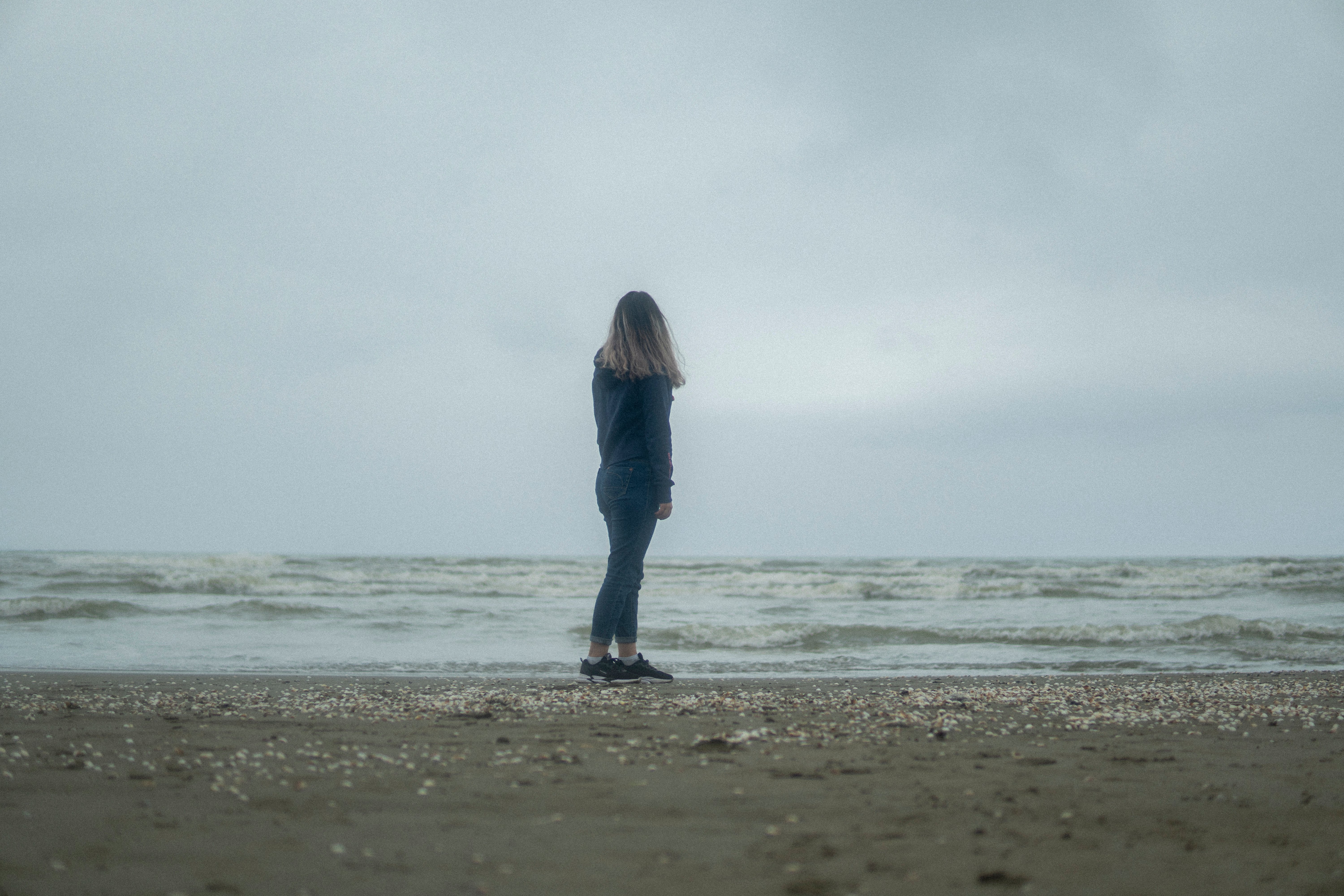 Woman Standing on the Sea Shore · Free Stock Photo