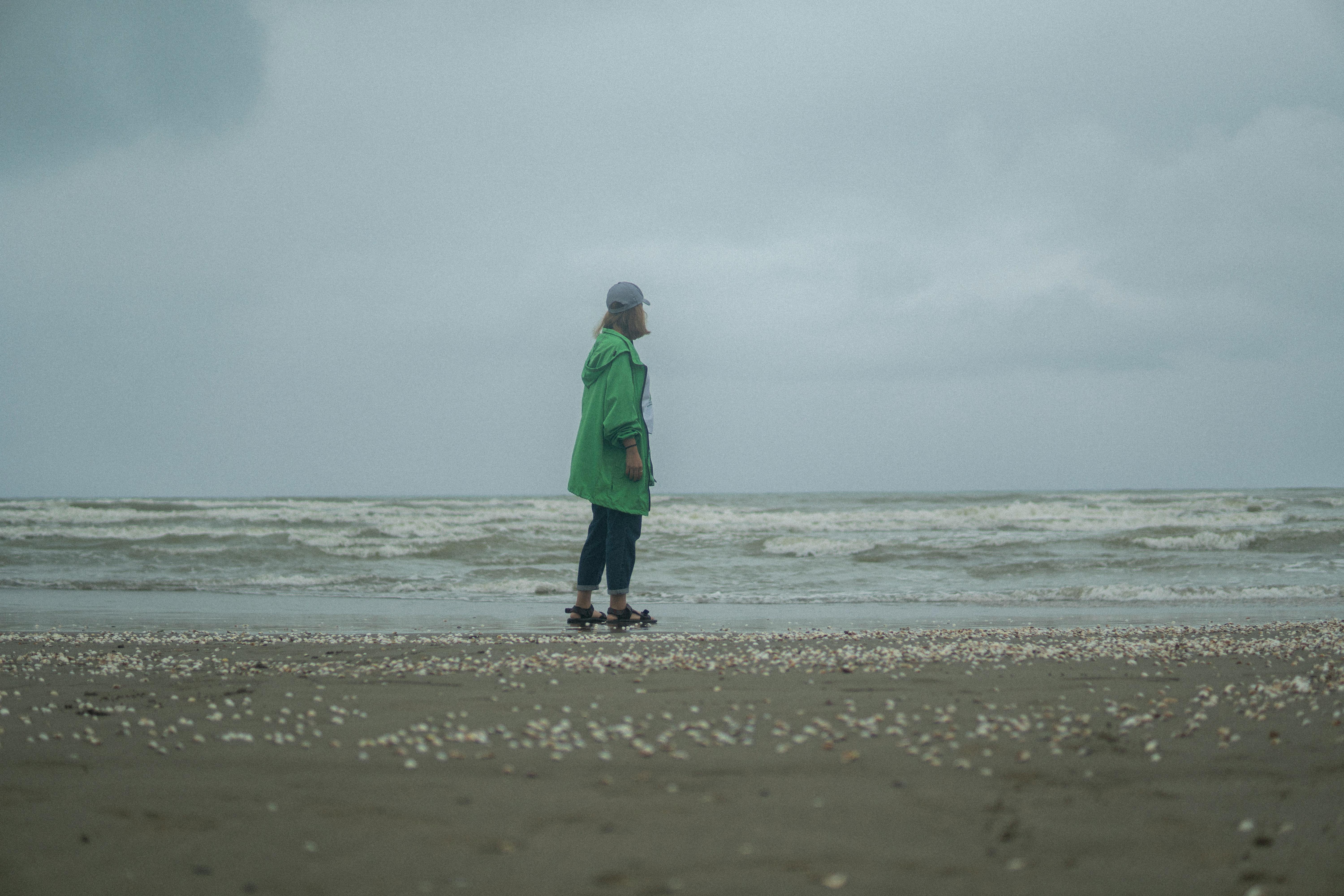 Woman Standing on the Sea Shore · Free Stock Photo