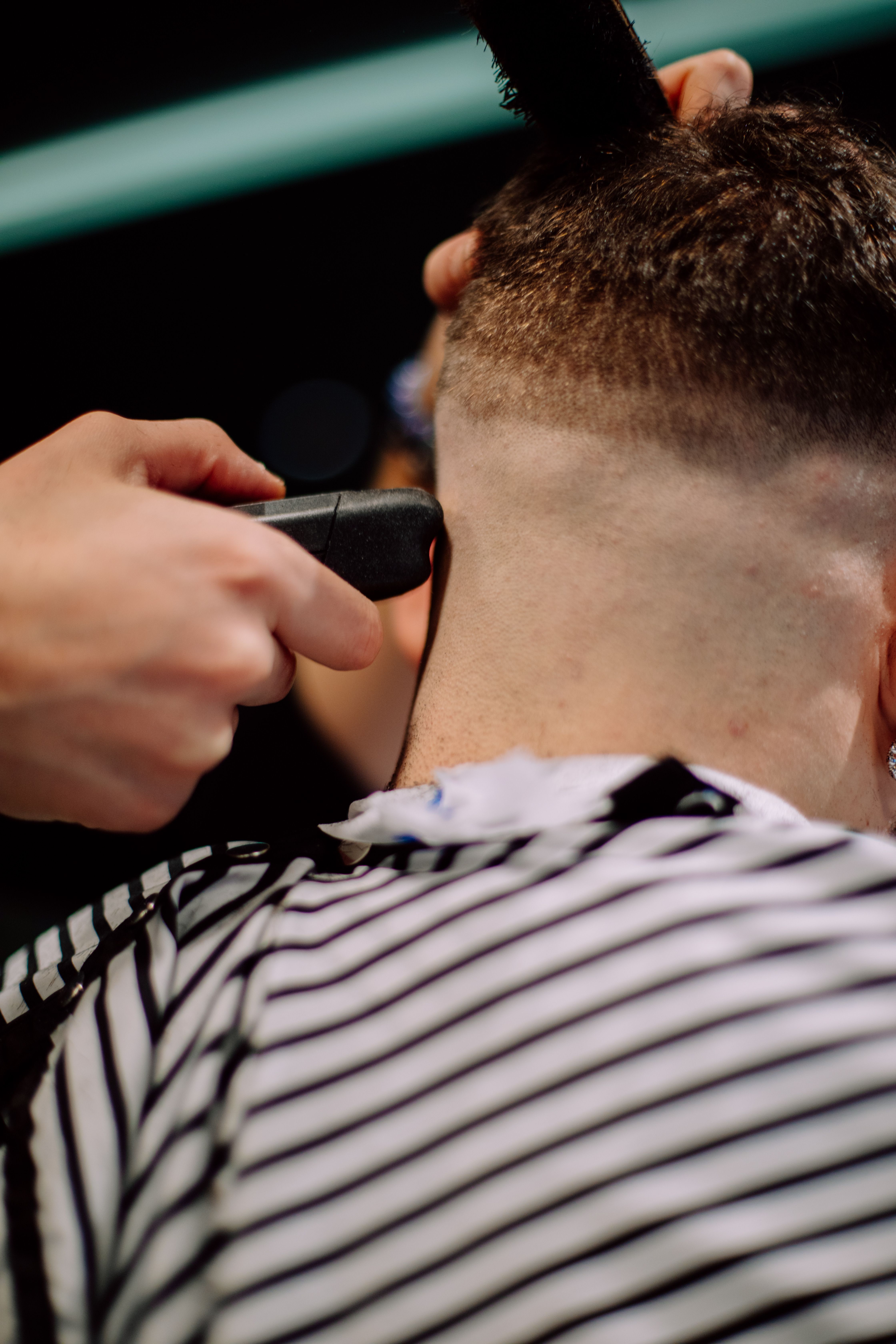A Barber Holding a Black Razor · Free Stock Photo