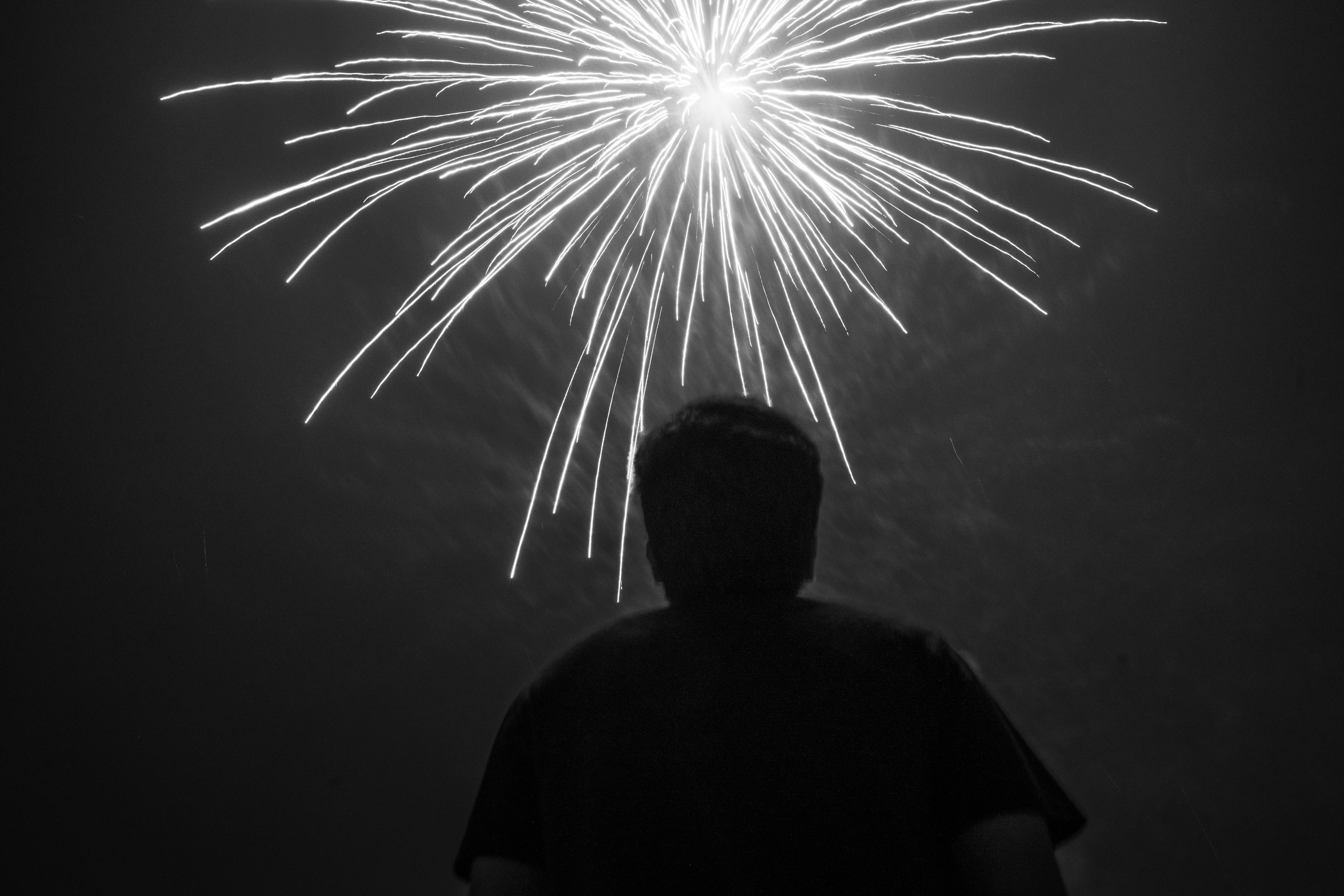 Low Angle Shot of Person looking on a Fireworks Display · Free Stock Photo