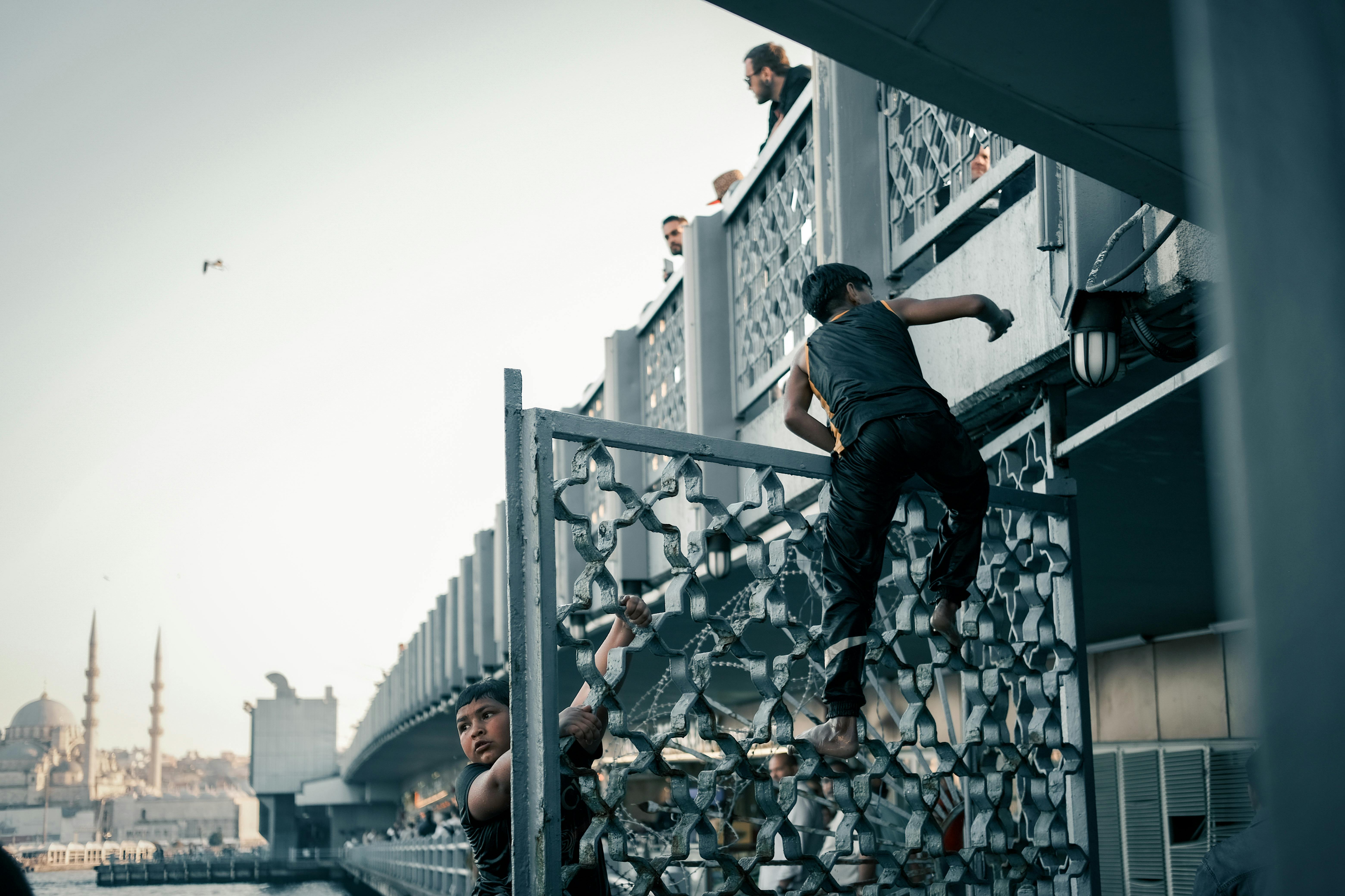 Kids climbing on a Metal Gate · Free Stock Photo