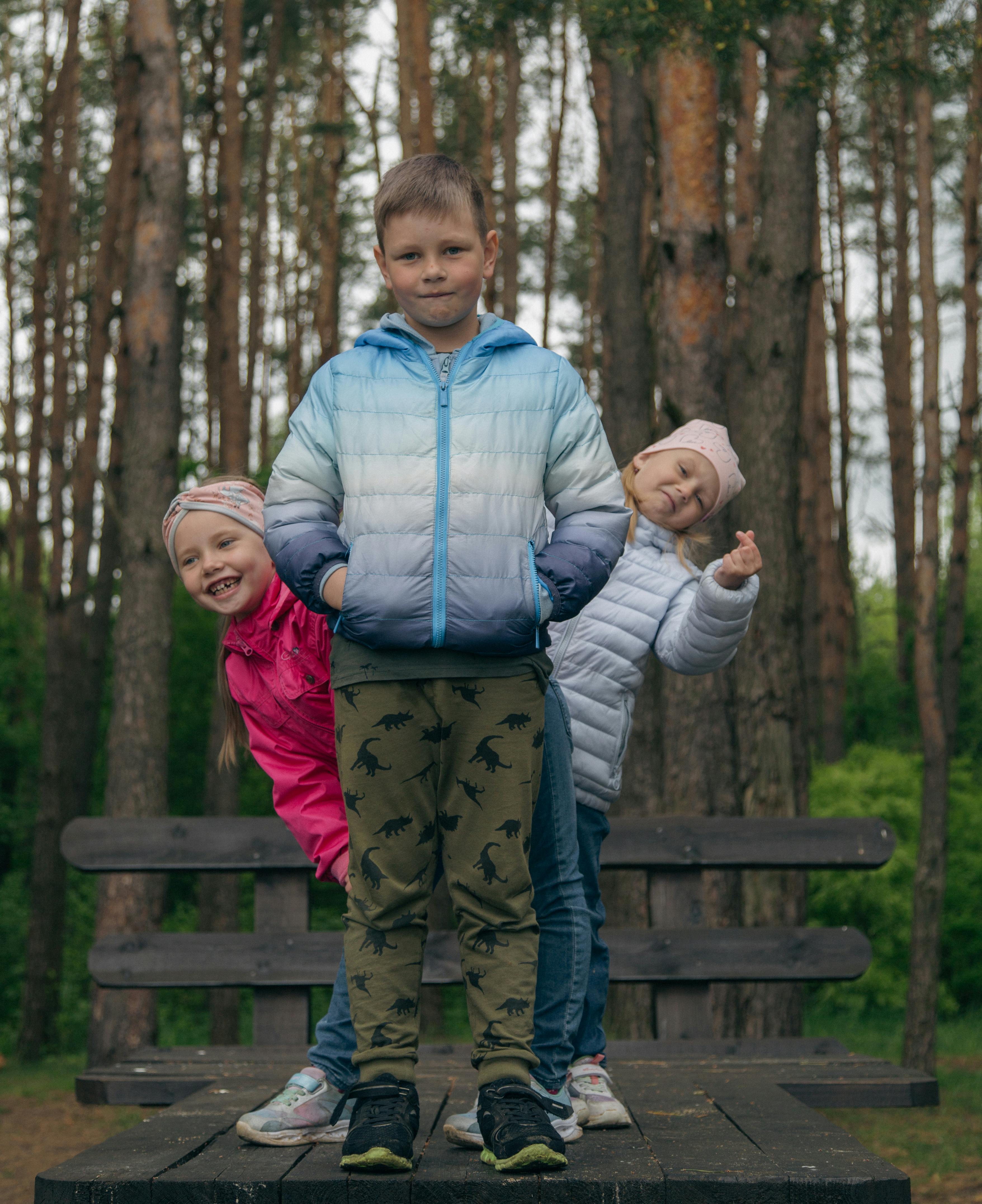 Happy Children standing on Wooden Table · Free Stock Photo