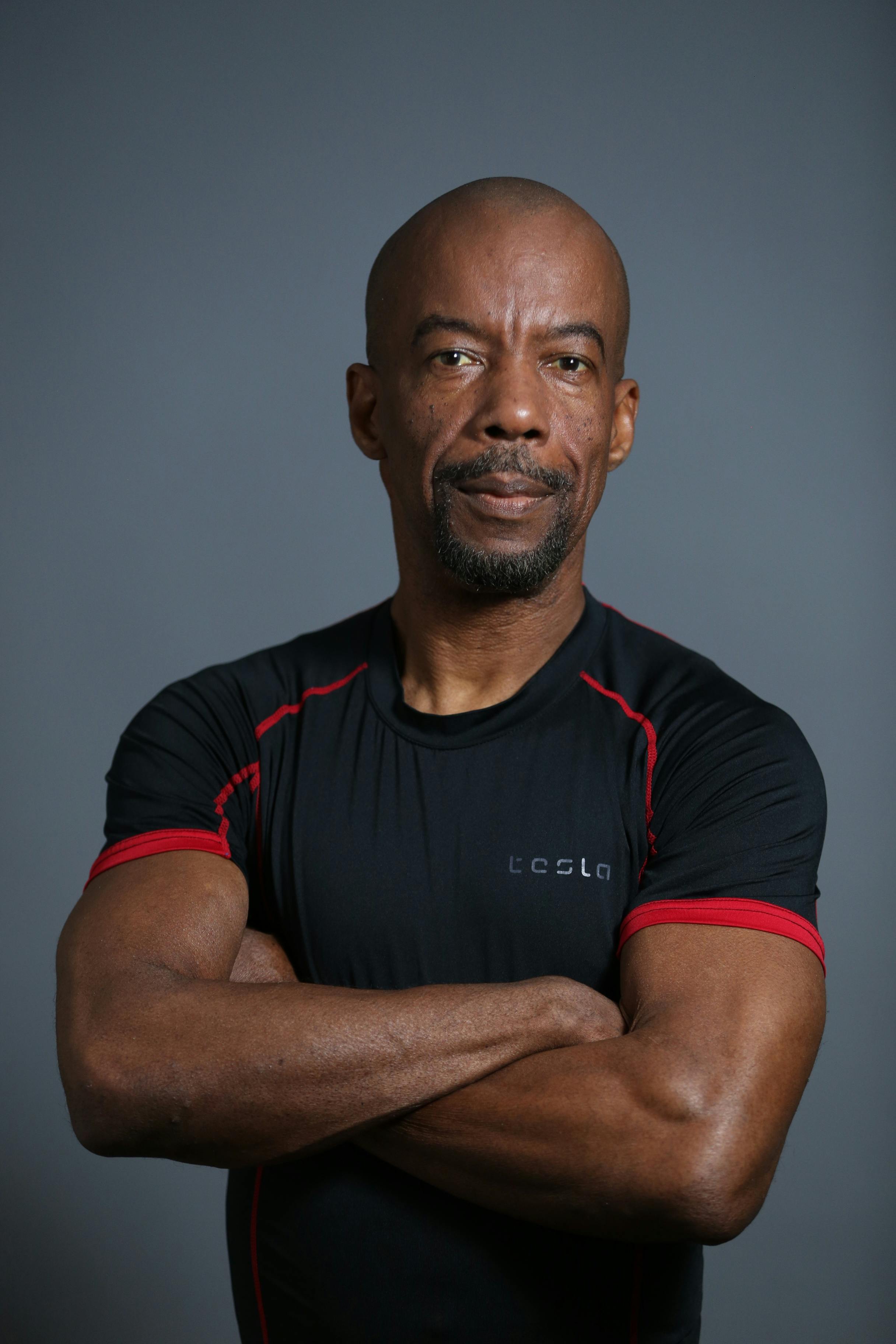 A Man in White Shirt Sitting Near a Tree Trunk · Free Stock Photo