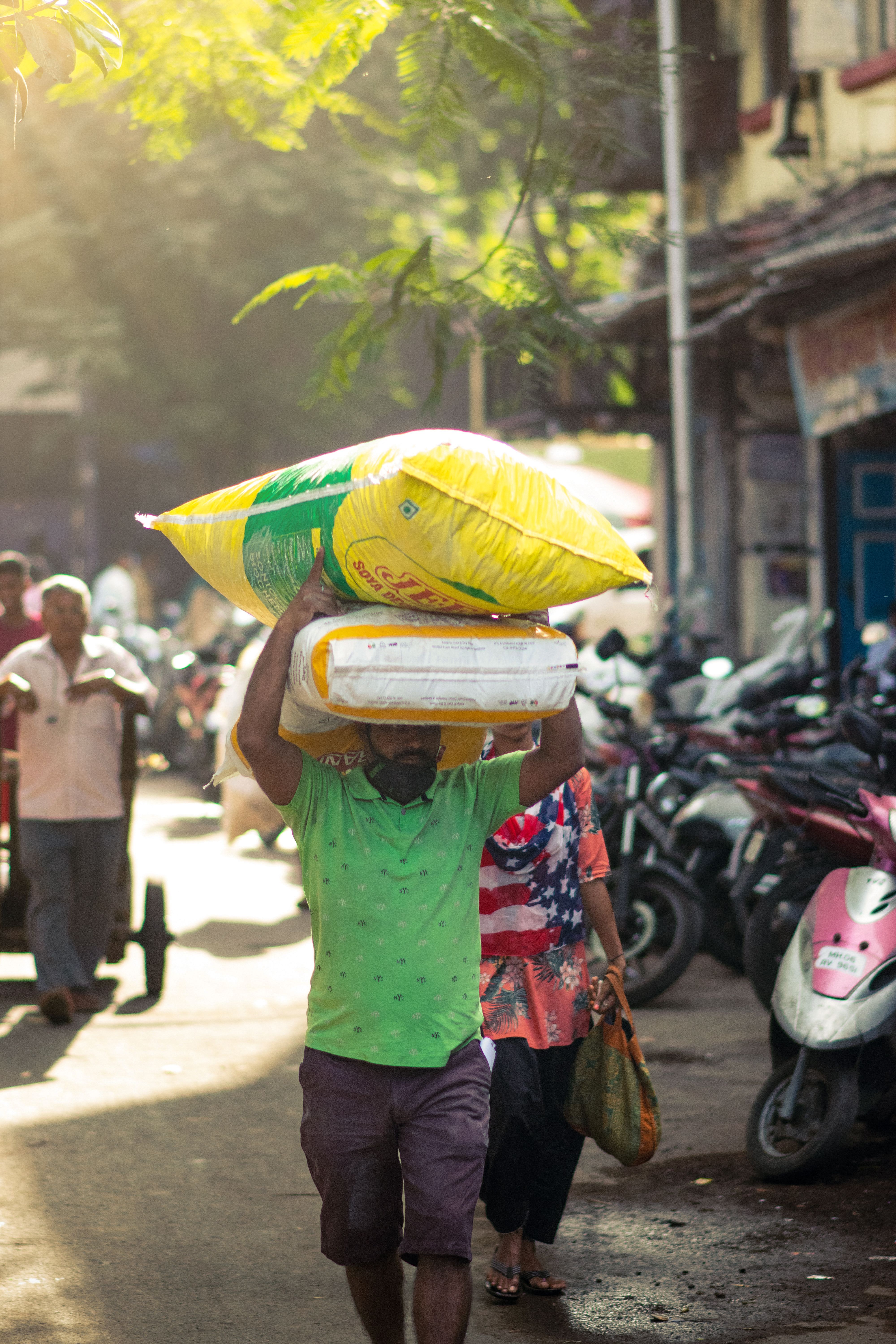 A Man Carrying Sacks Over the Head · Free Stock Photo