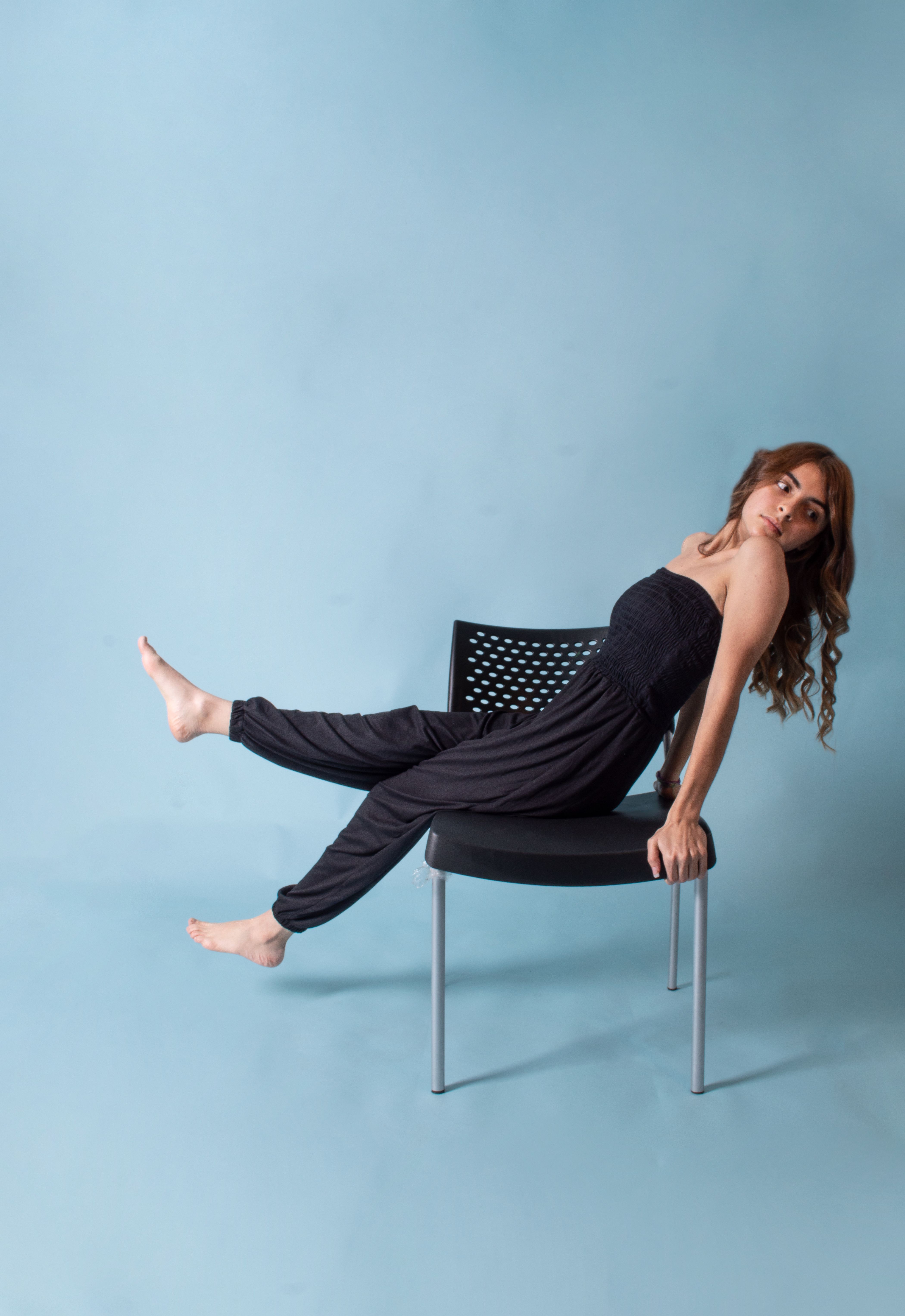 A Woman in Blue Jeans Sitting on a Chair · Free Stock Photo