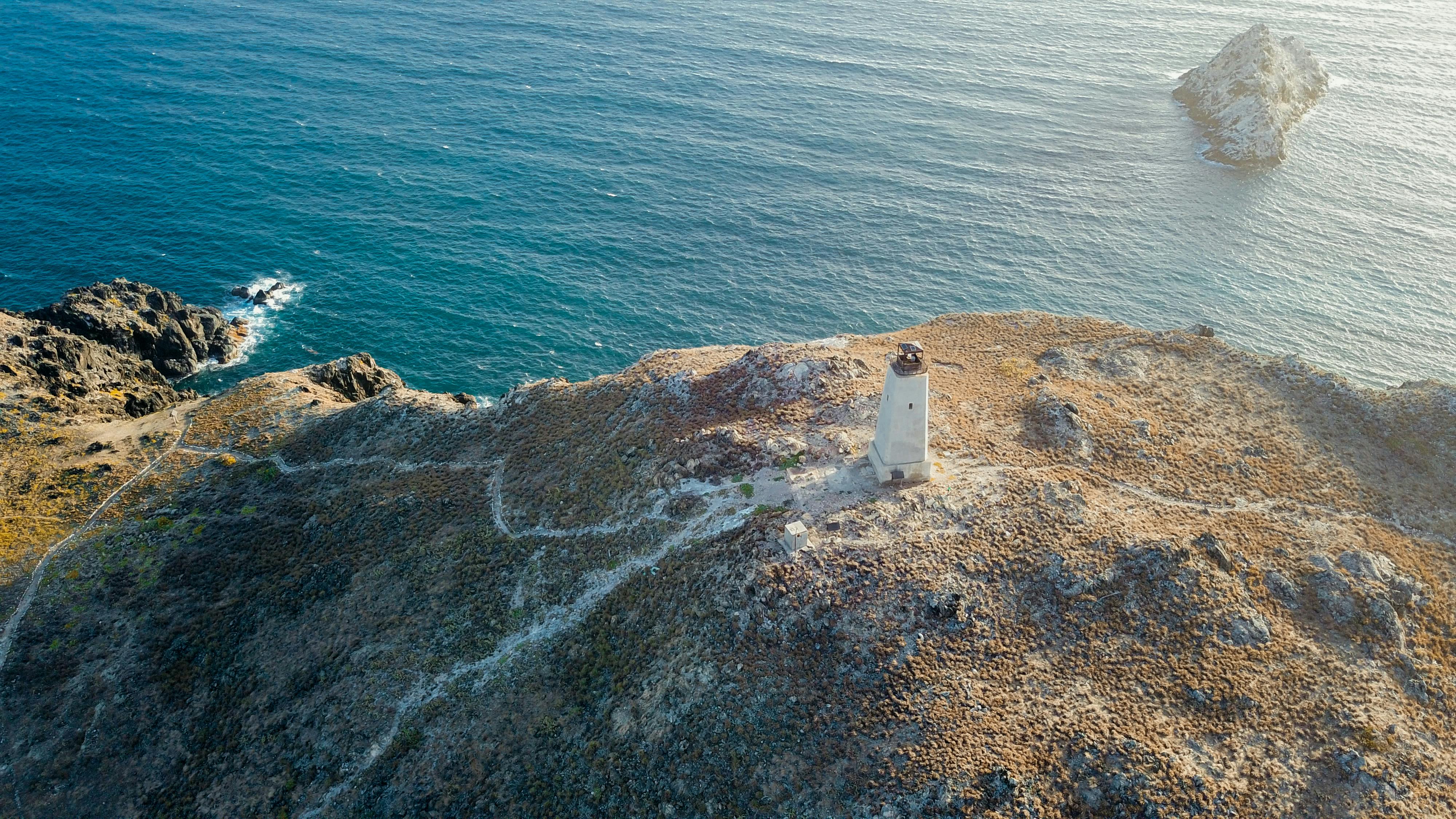 Aerial View of a Lighthouse on a Cliff · Free Stock Photo