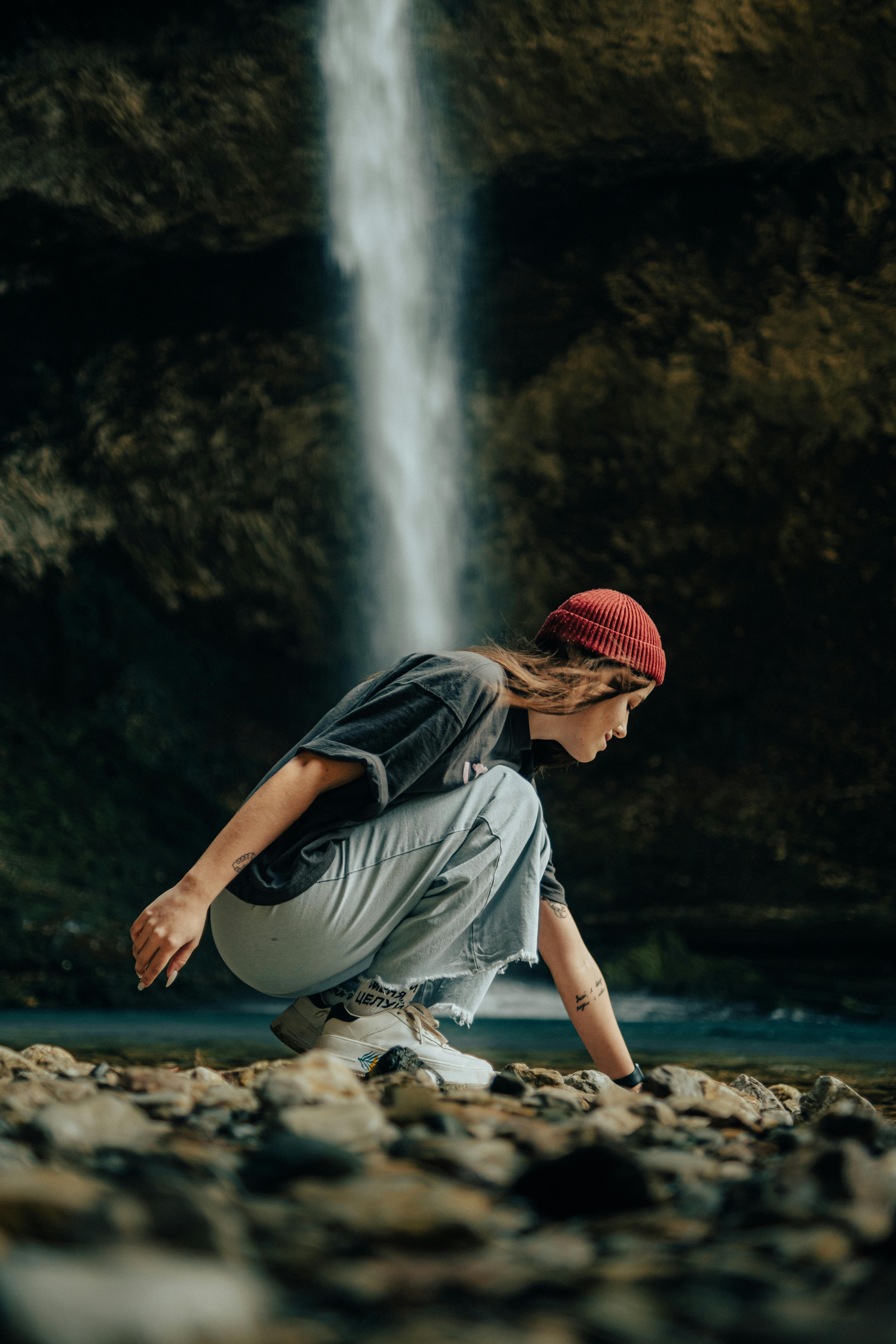 Woman Crouching on Rock · Free Stock Photo