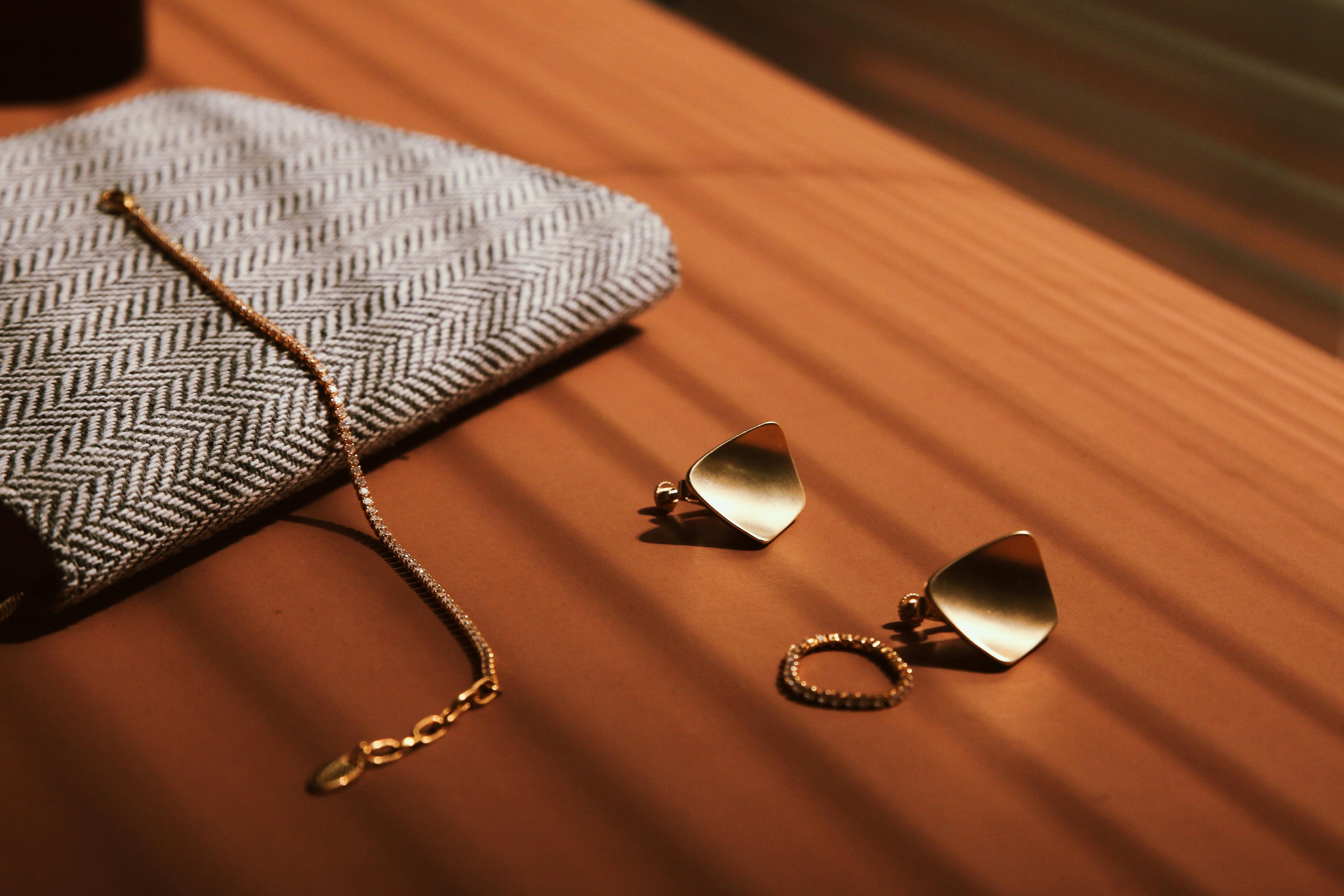 Golden Jewelry on Table · Free Stock Photo