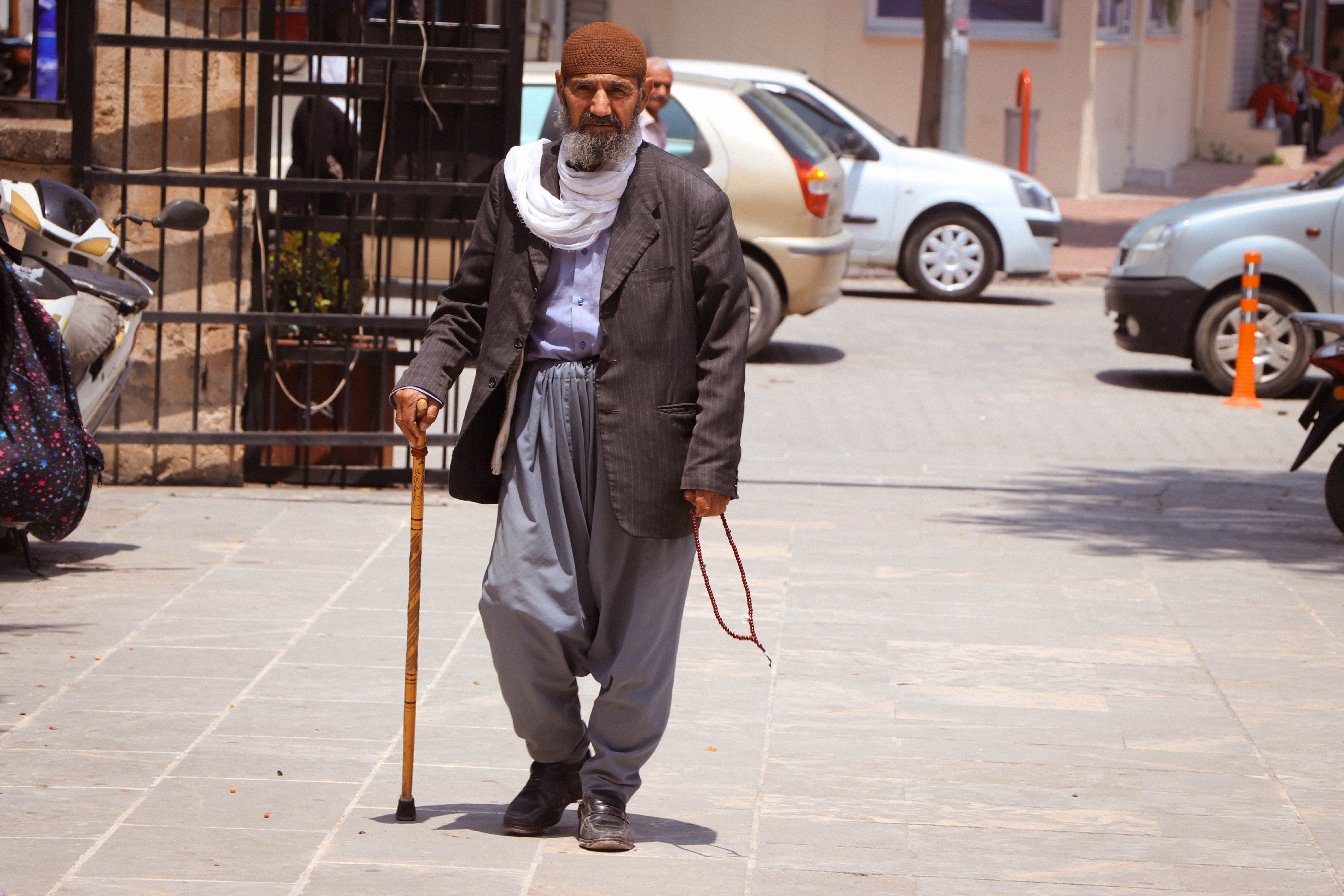 Bearded Man Walking with Cane · Free Stock Photo