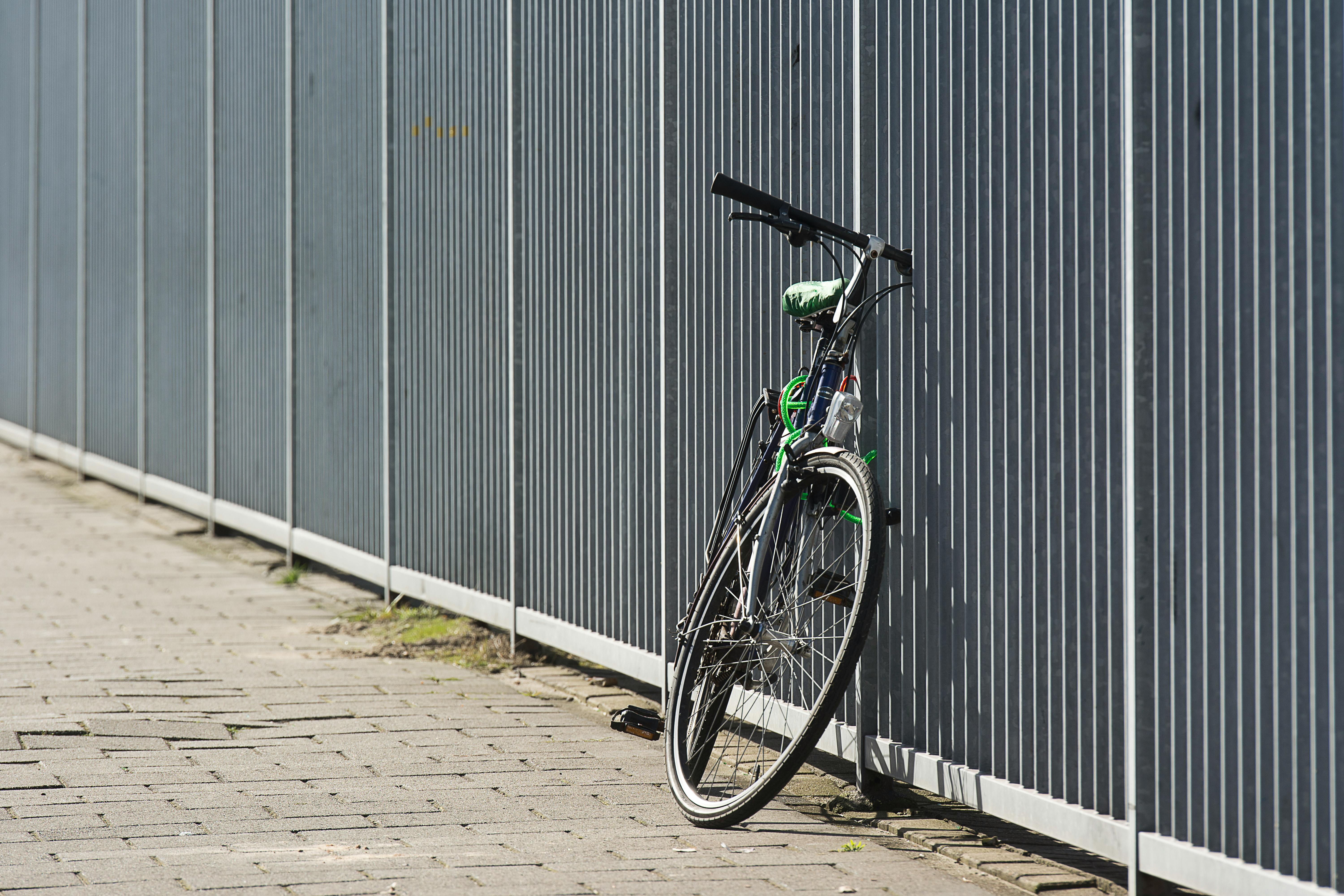 Bike Attached to a Fence · Free Stock Photo