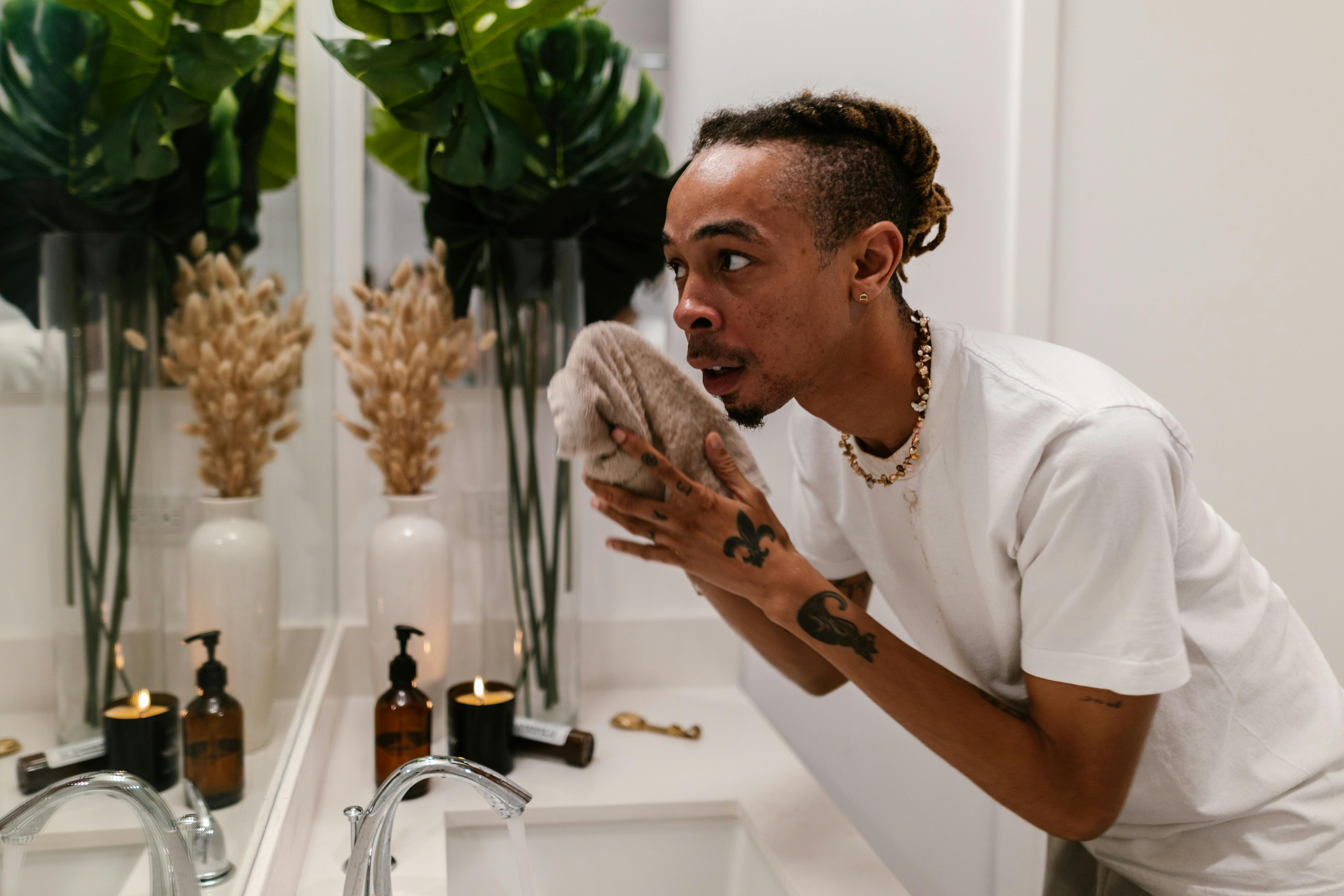 Man with Tattoos Washing Hands in Sink · Free Stock Photo