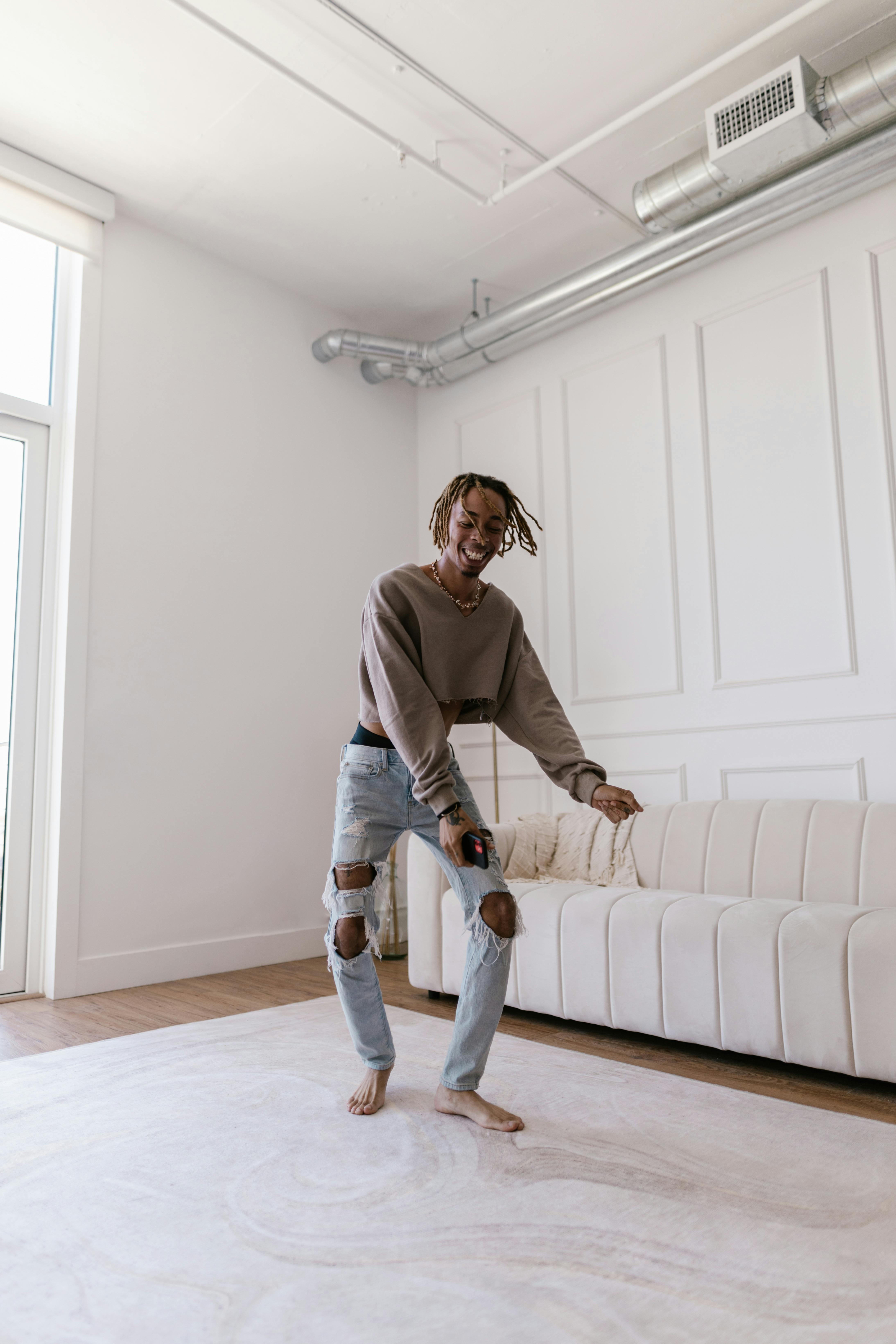 Happy Young Man Dancing in Living Room · Free Stock Photo