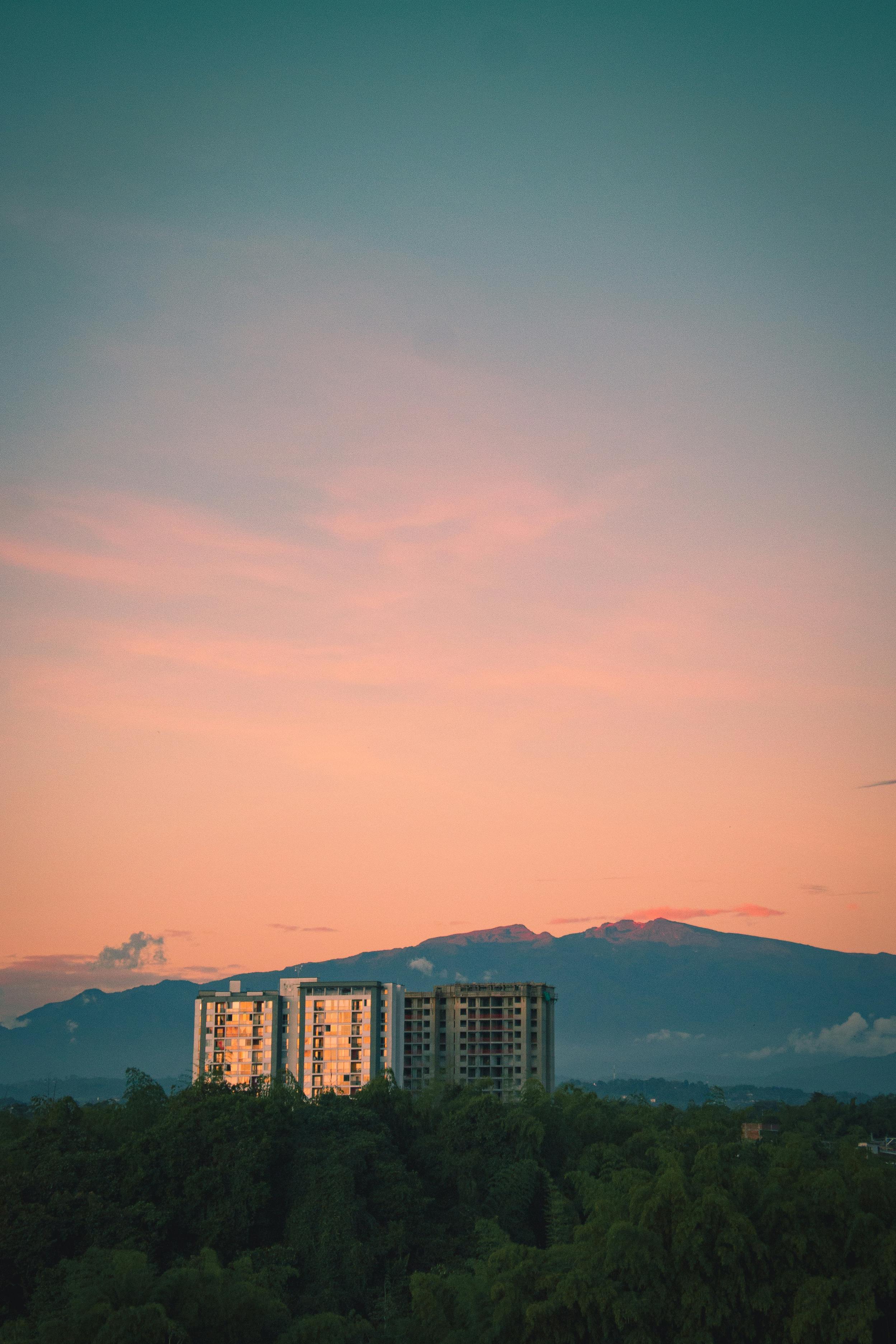 Apartment Building in Mountain Landscape on Sunset · Free Stock Photo