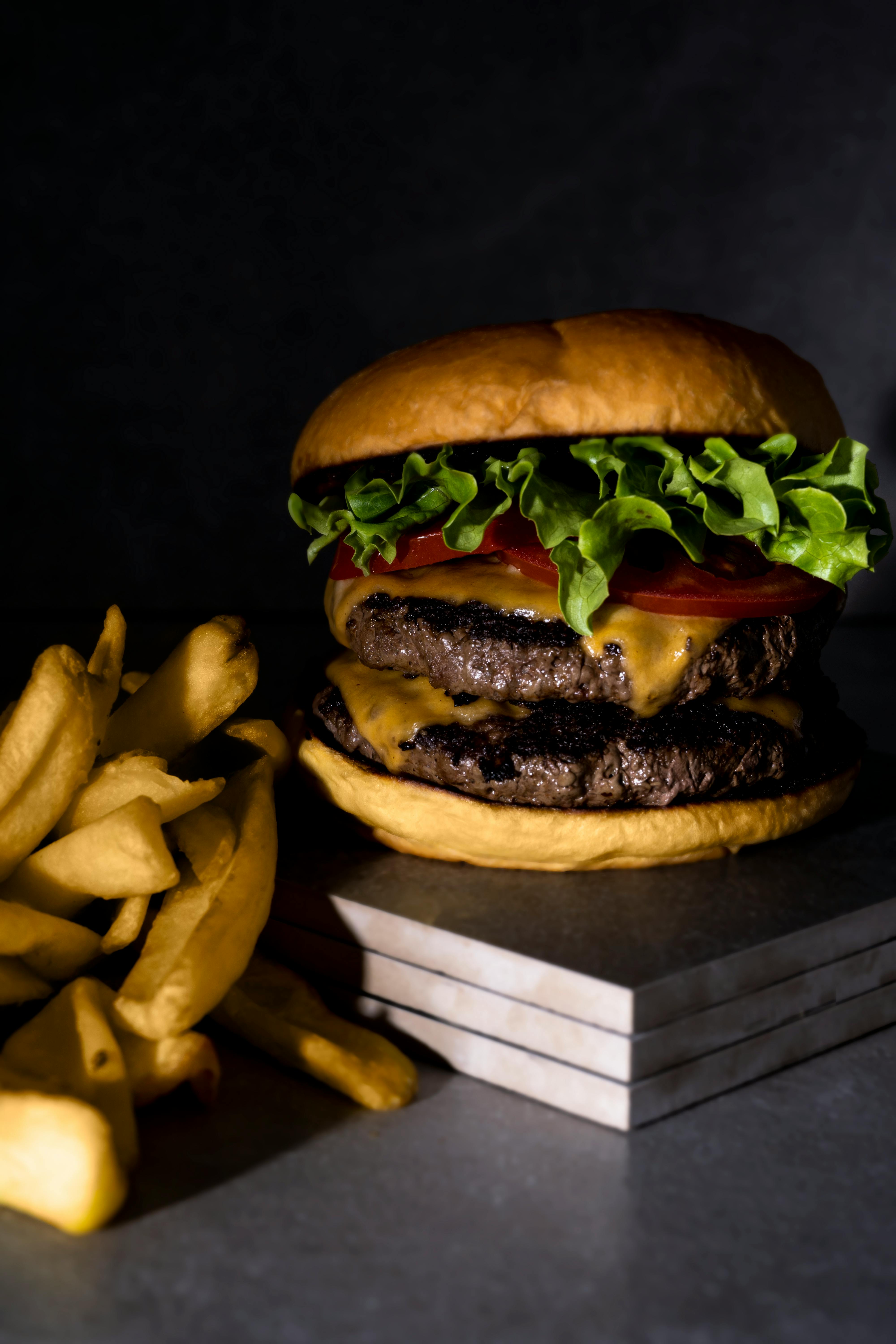 Photo of a Cheeseburger Near a Magazine · Free Stock Photo