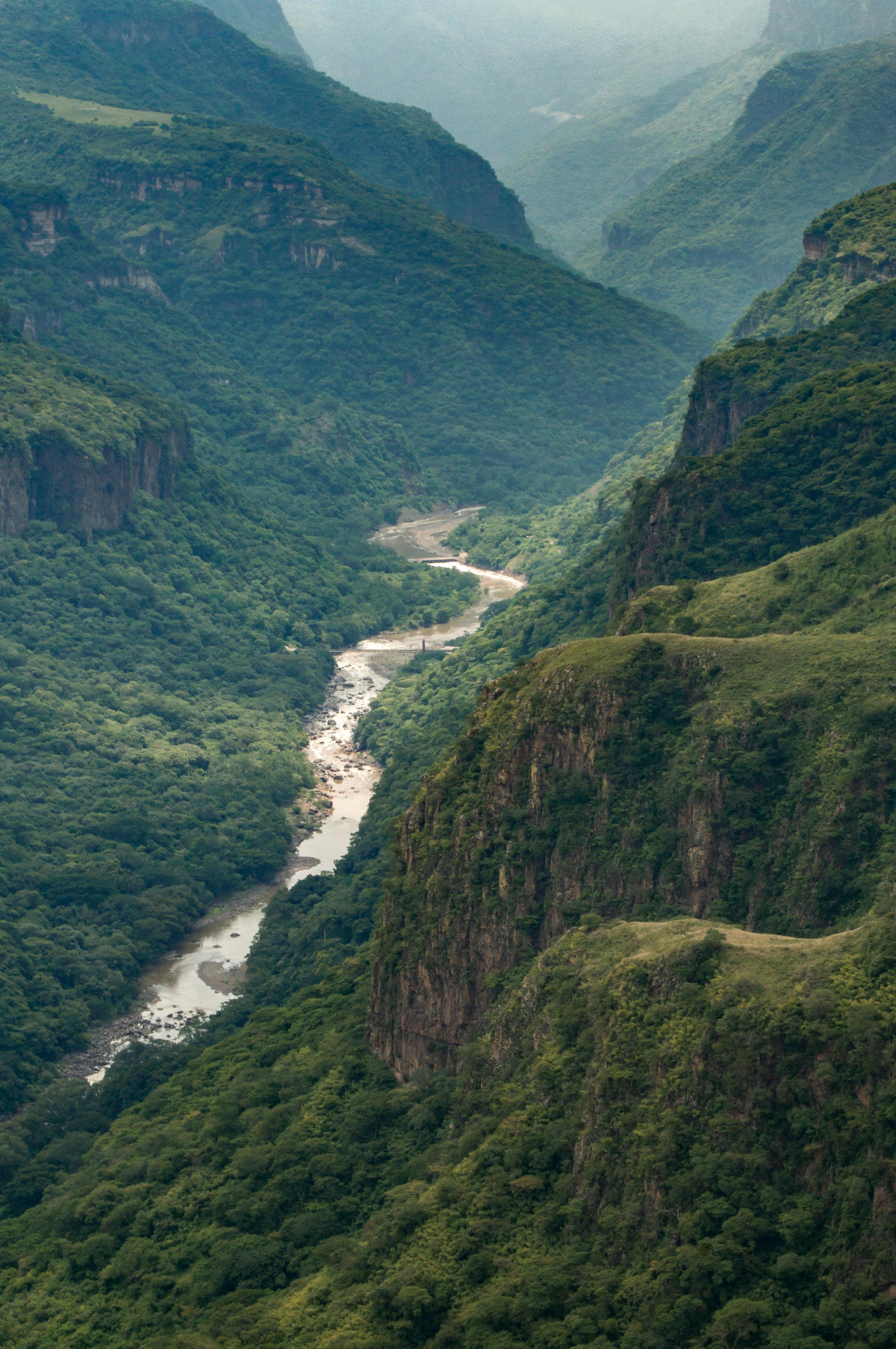 River in Between Mountains · Free Stock Photo