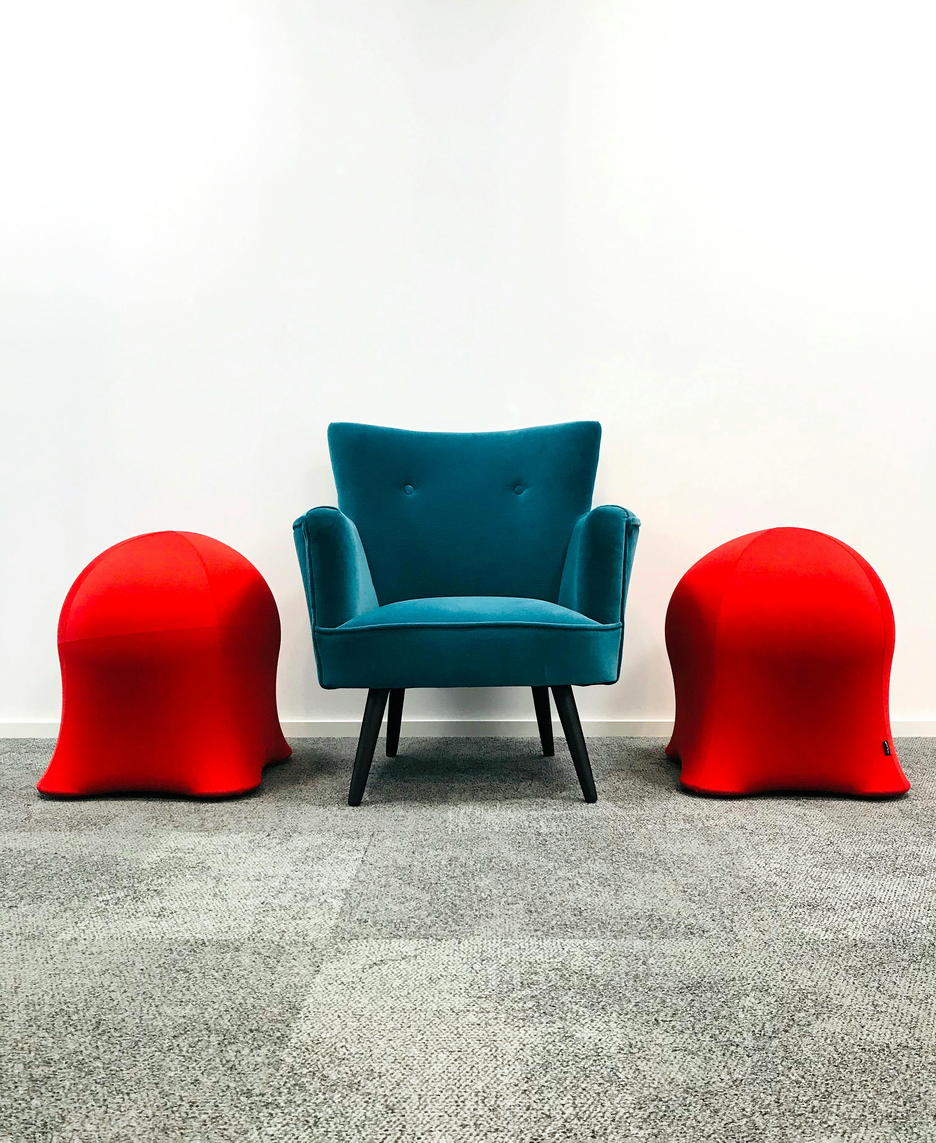 Red Chair Beside Teal Wall · Free Stock Photo