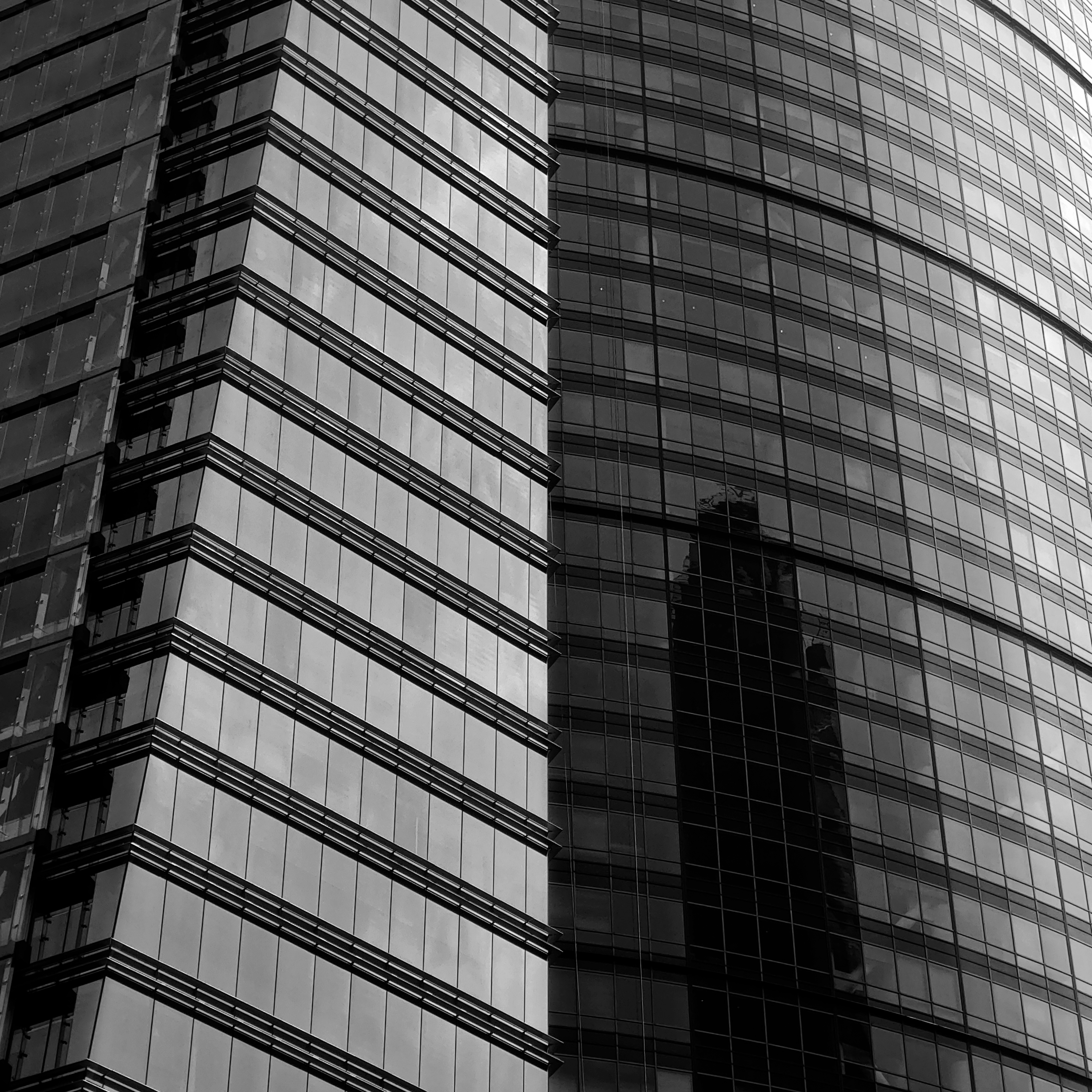 Monochrome Photo of a Building with Glass Windows · Free Stock Photo