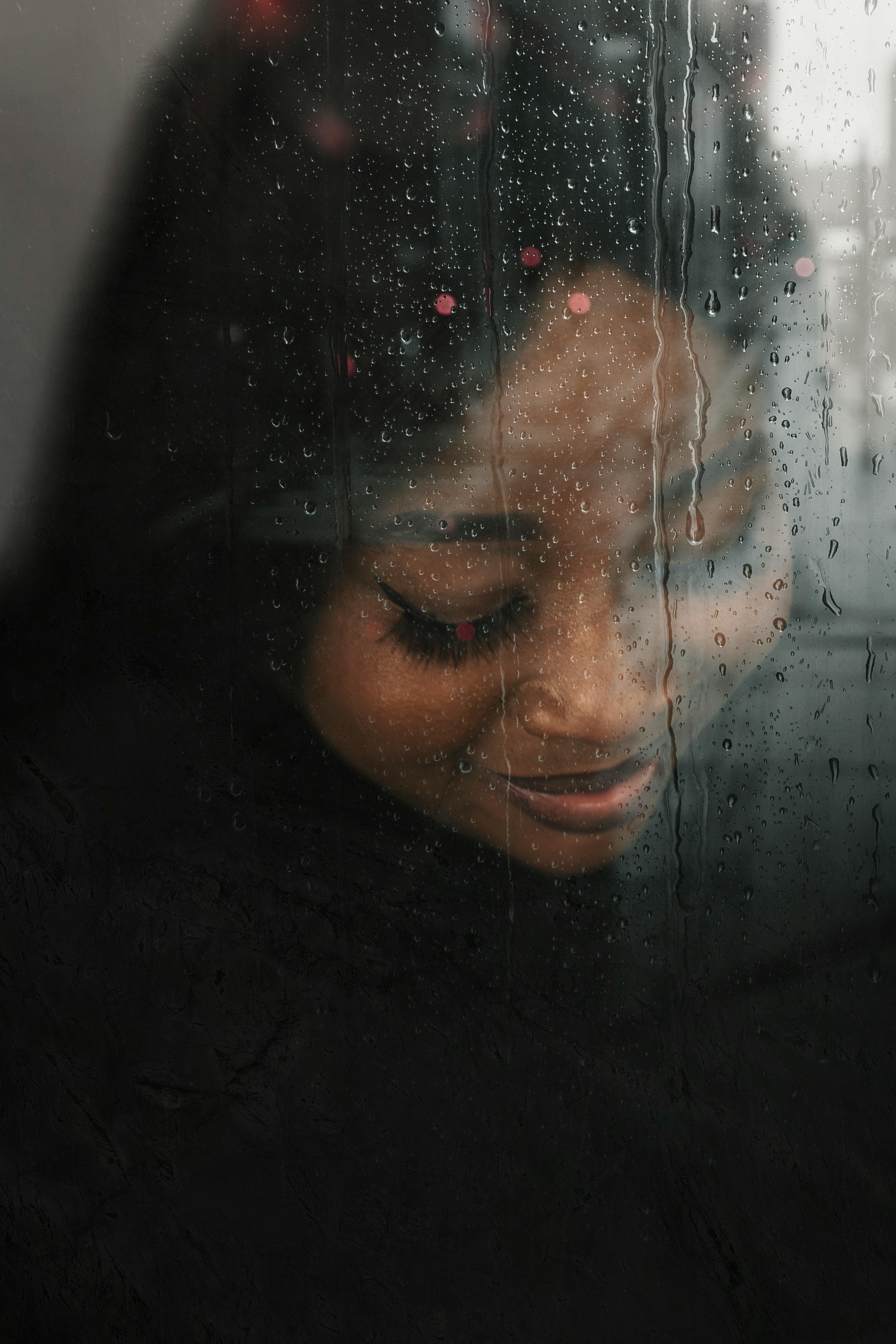 Face of Young Smiling Woman Behind Window Pane · Free Stock Photo