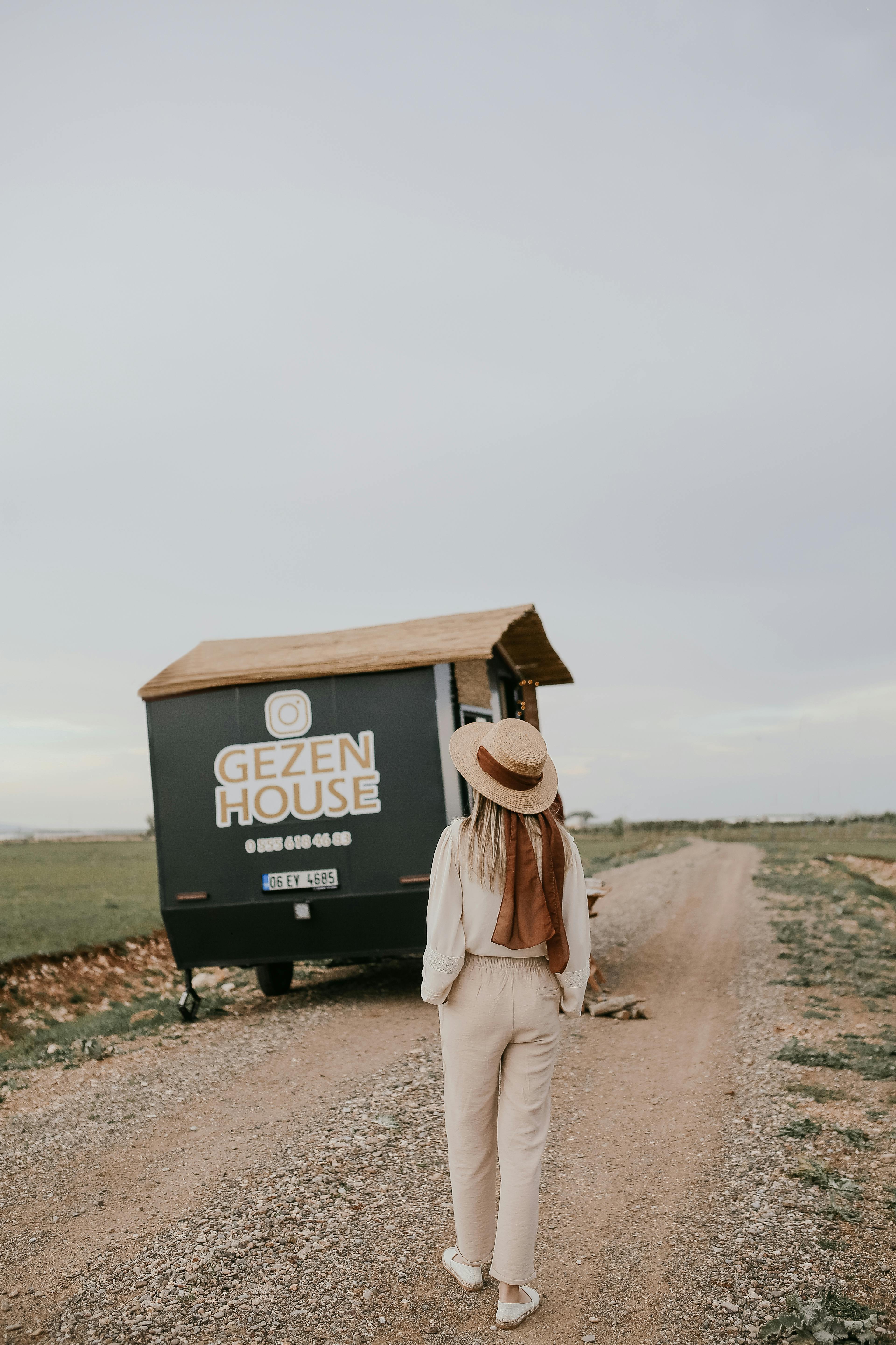 Woman Lighting a Fire in the Fireplace in a Tiny House on Wheels · Free ...