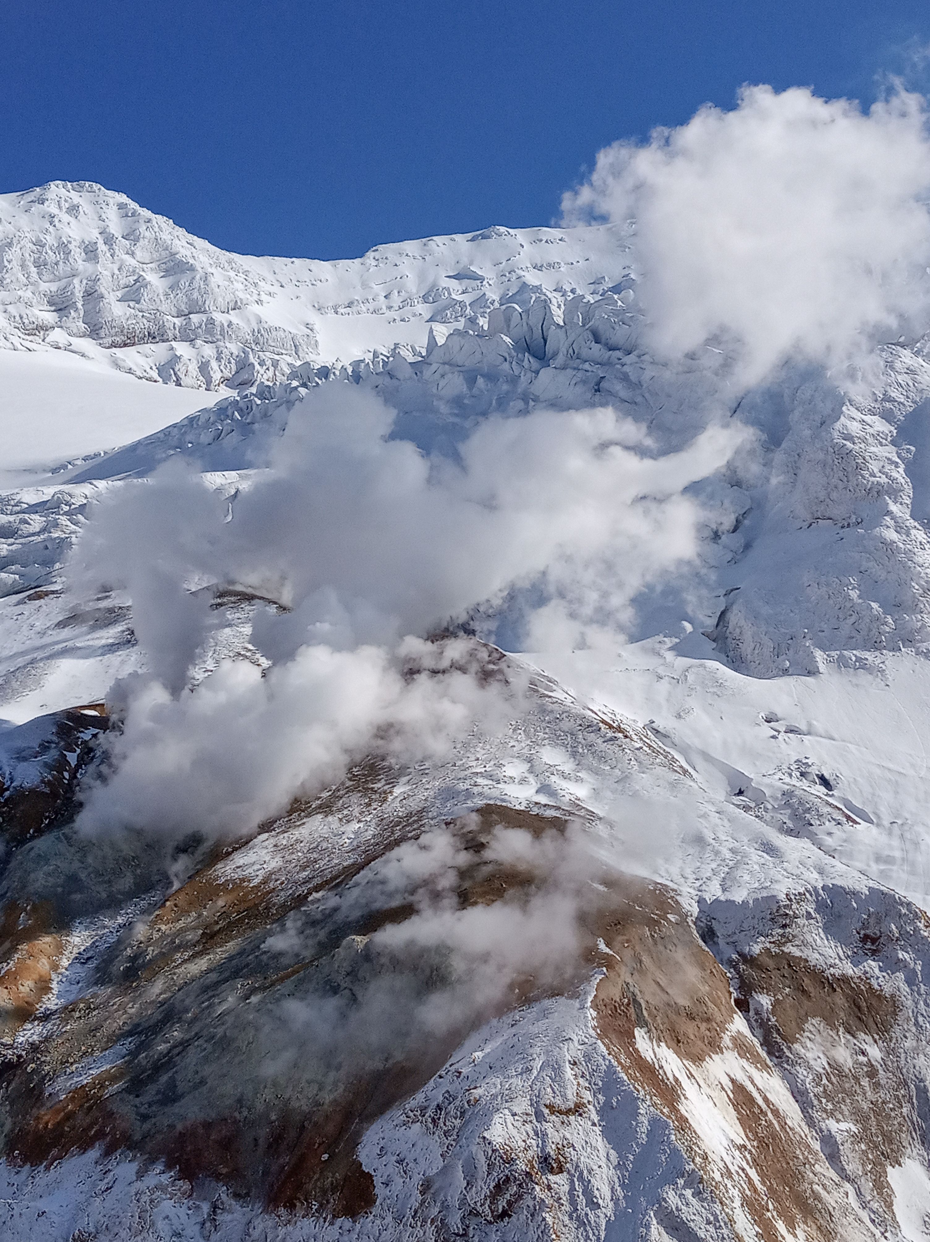 Mist Over a Snowy Mountain · Free Stock Photo