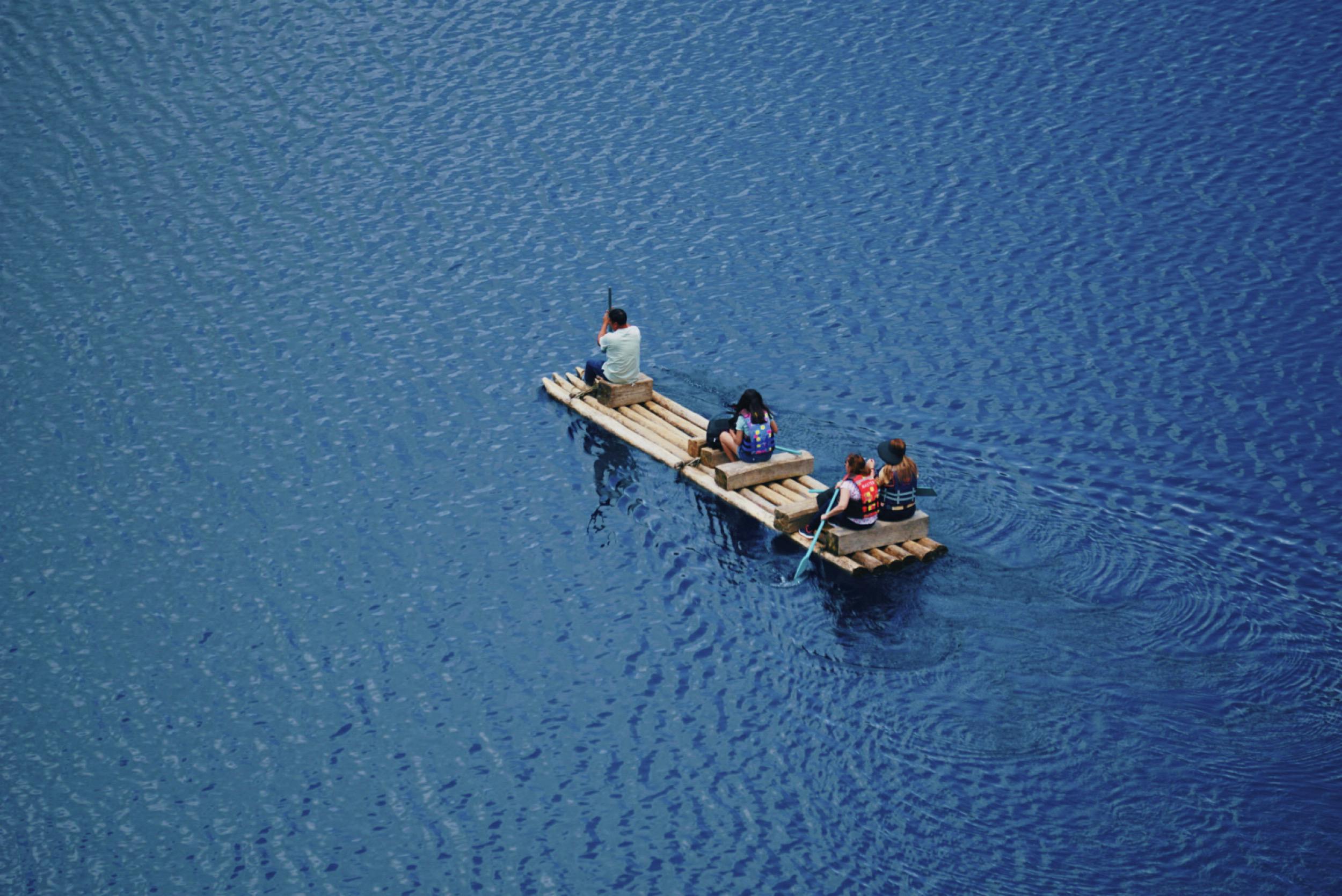 People Riding a Wooden Raft · Free Stock Photo